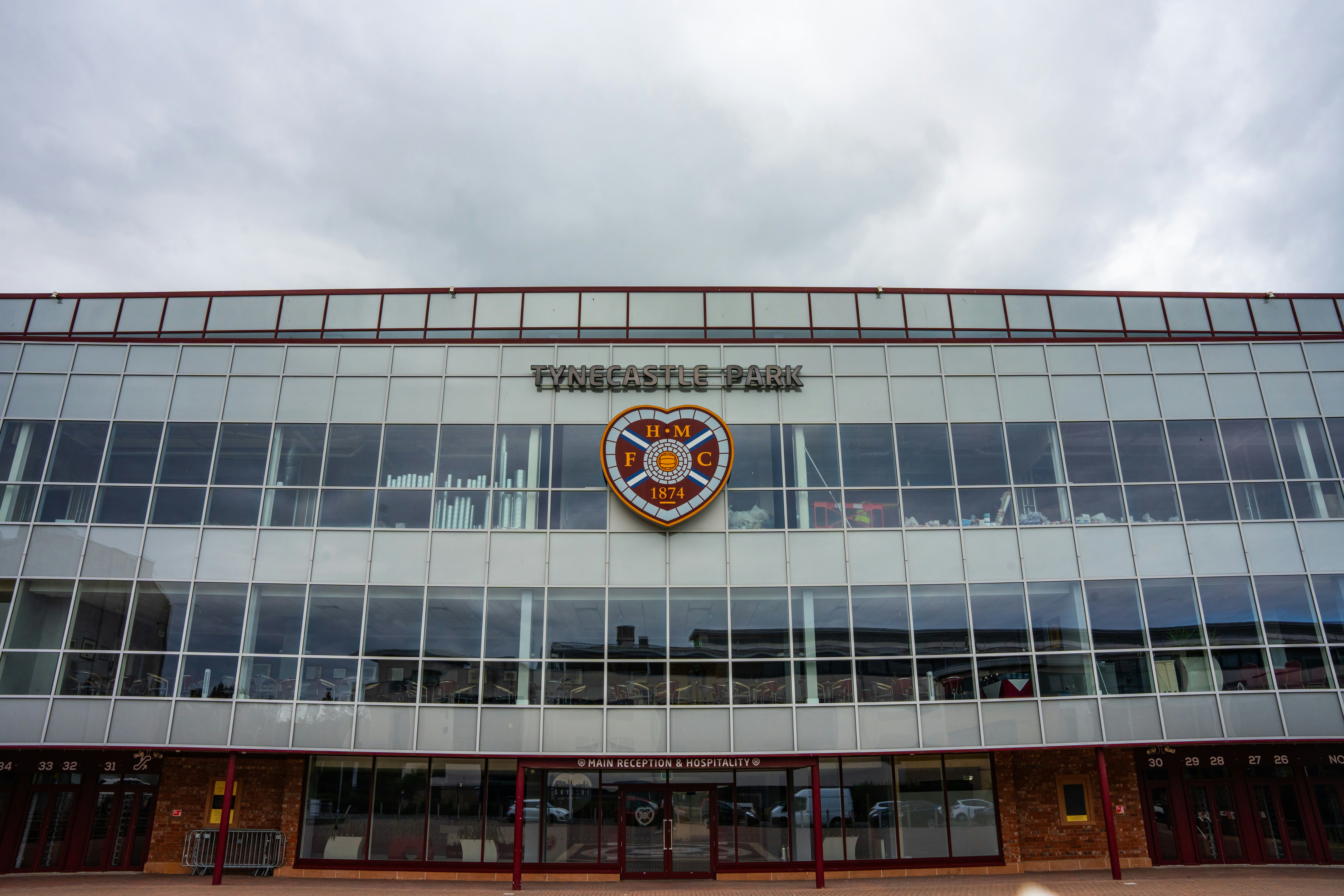 Crest Centered on Glass: A Stadium Facade's Quiet Symmetry