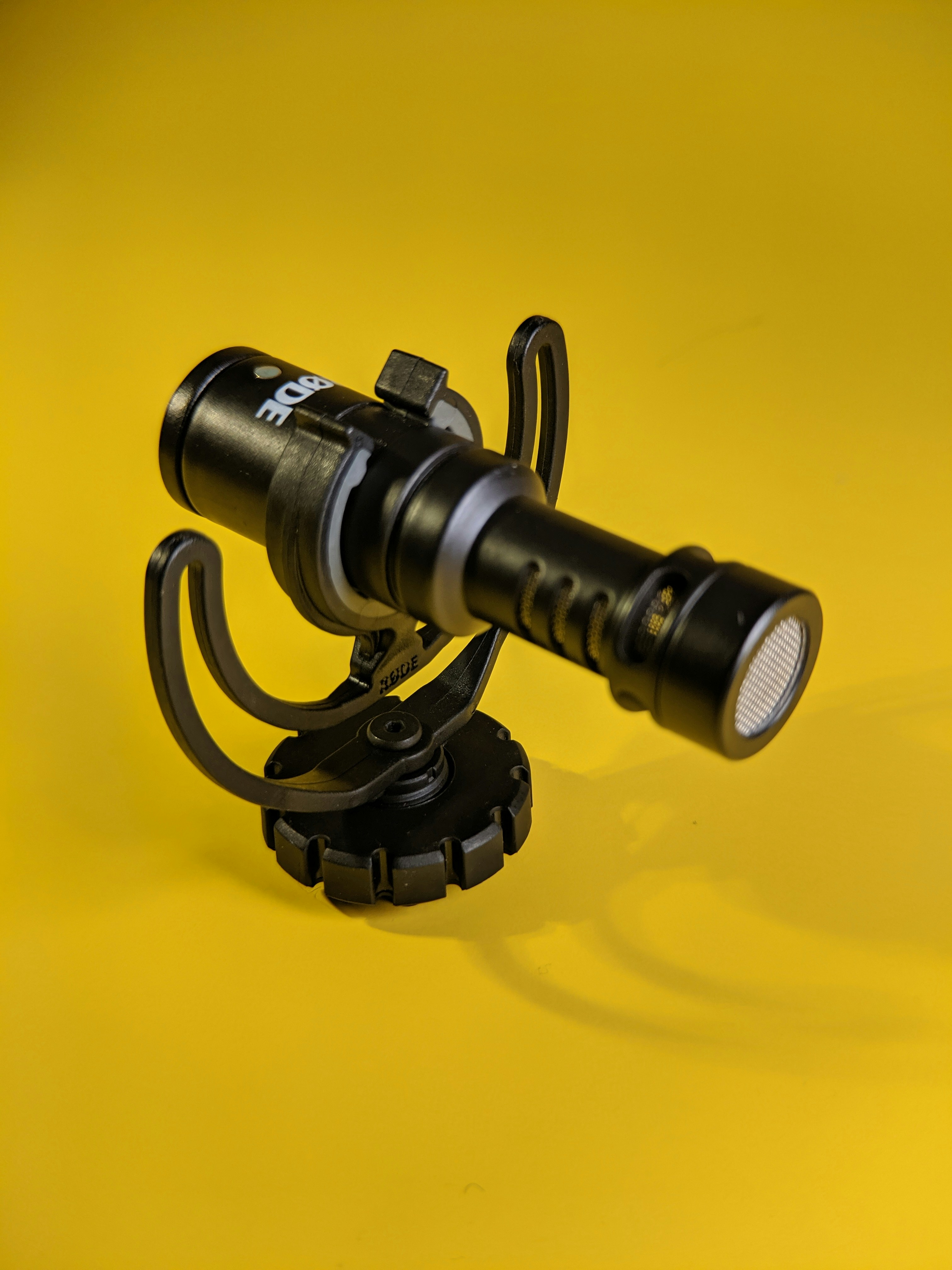 a close up of a flashlight on a yellow background