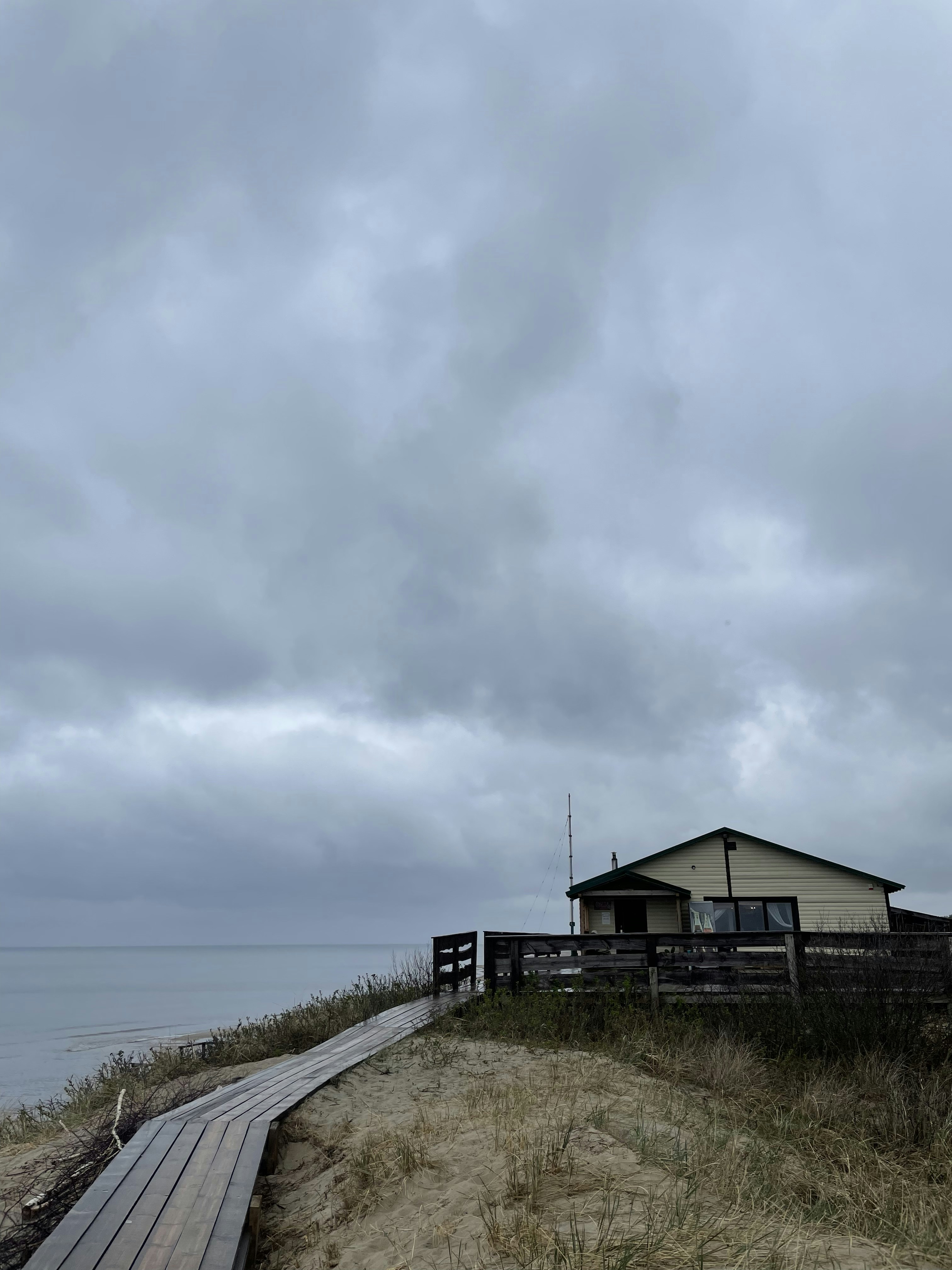 Dune-Edge Cabin Beneath a Brooding Coastal Sky
