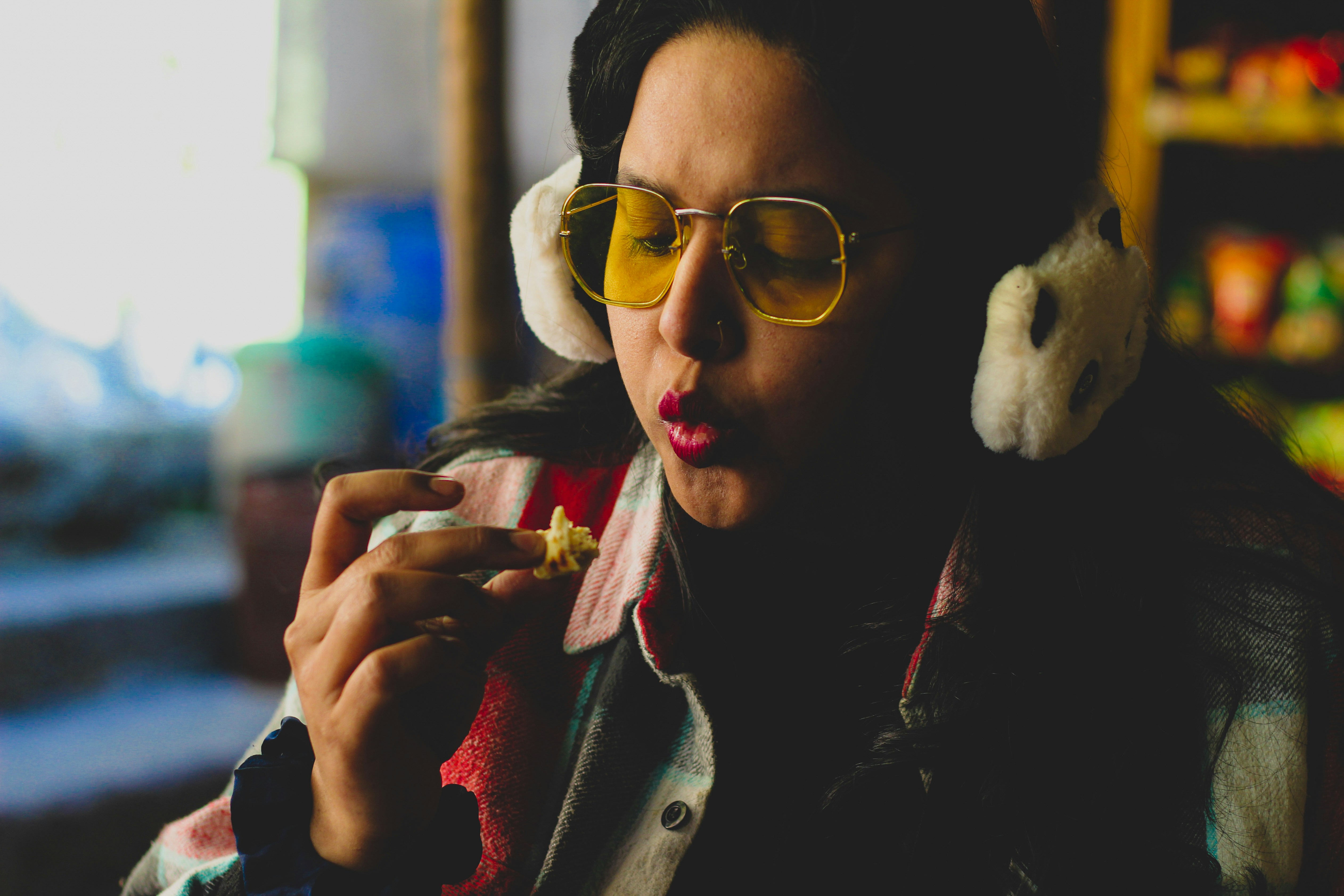 Yellow-tinted Escape: A Moment of Munching in Headphones and Hooded Warmth