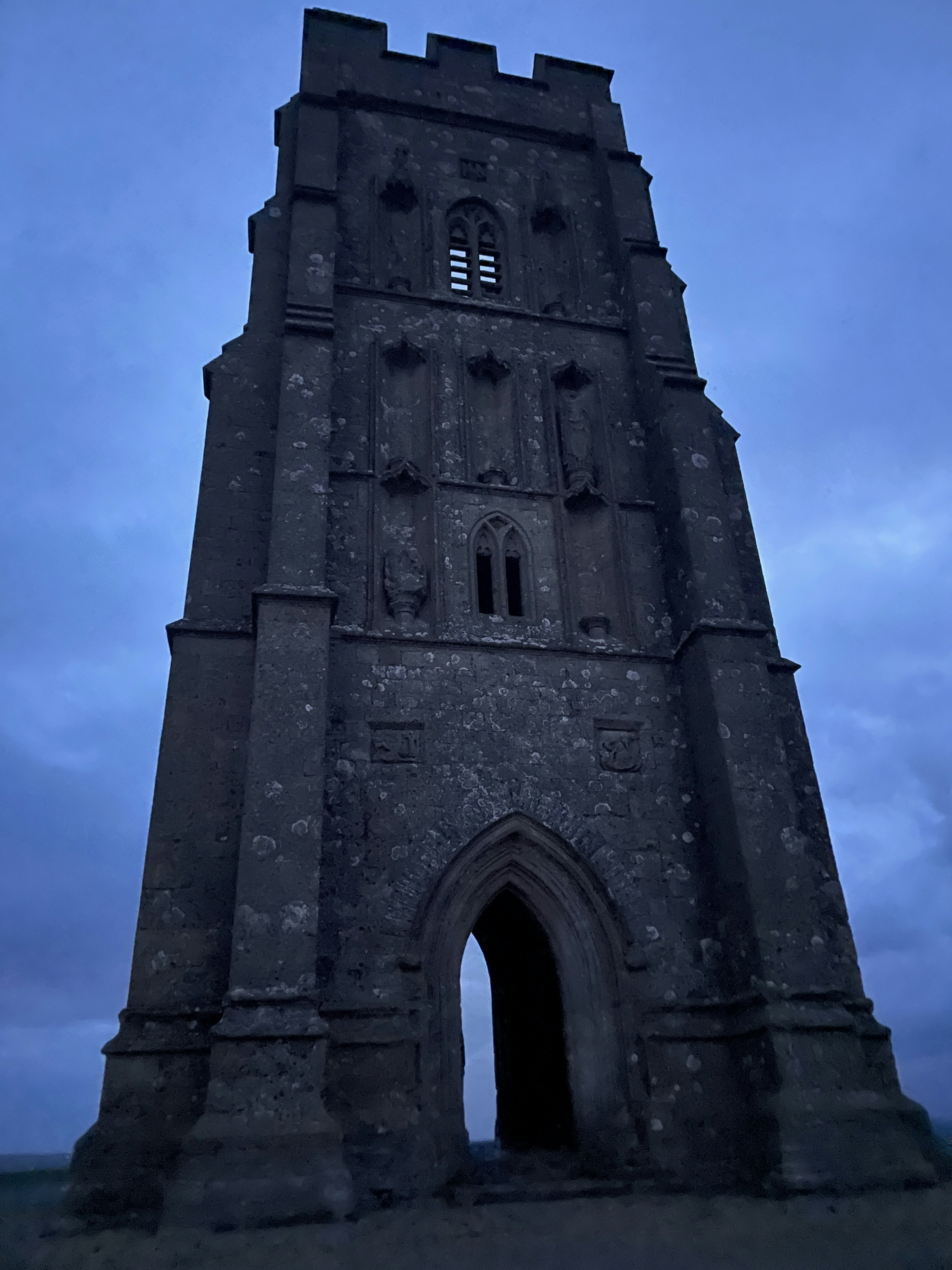 Blue Hour Bastion: A solitary coastal tower framed against the sea