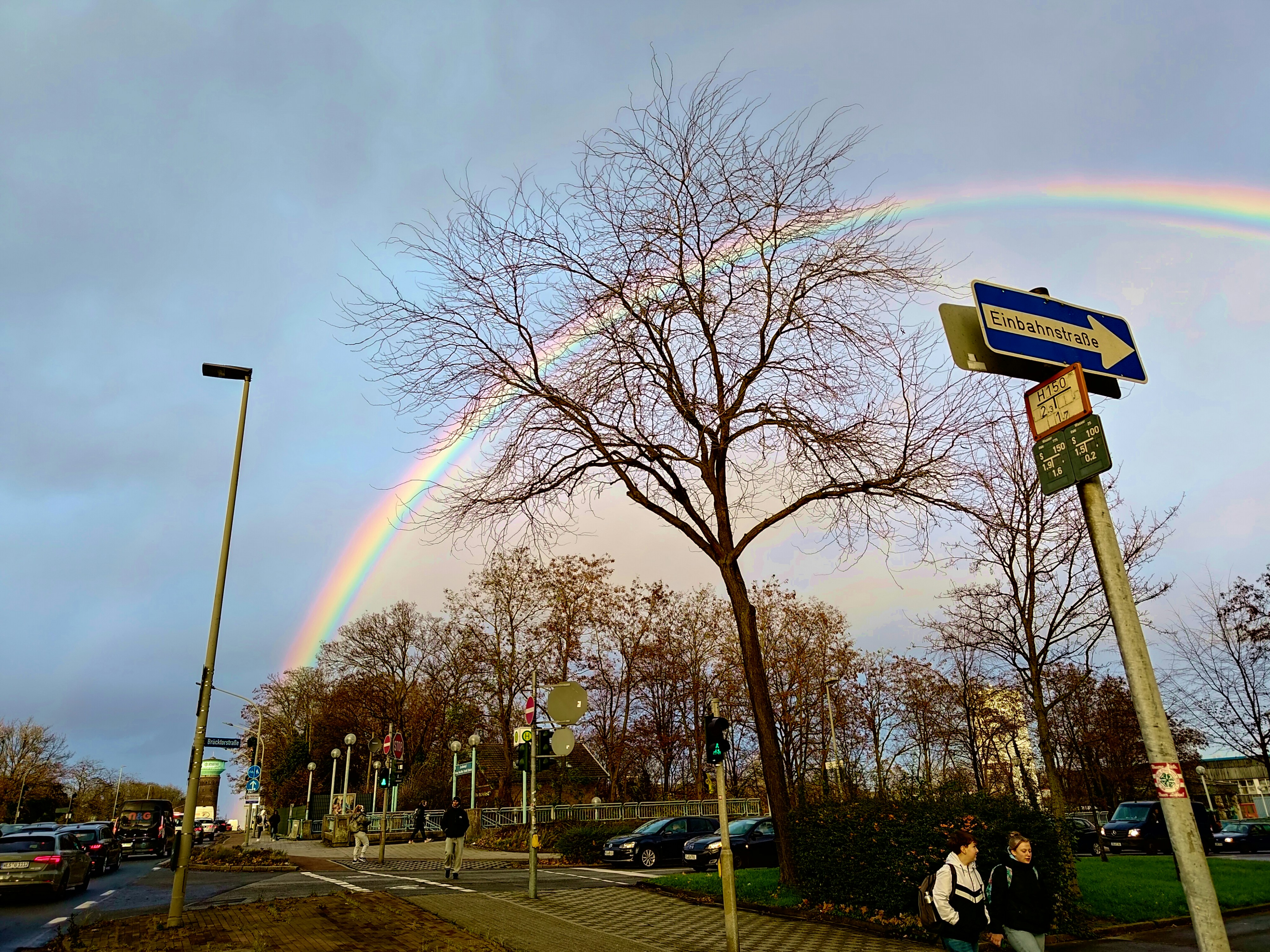 A double rainbow in the sky over a street photo – Free Car Image on ...