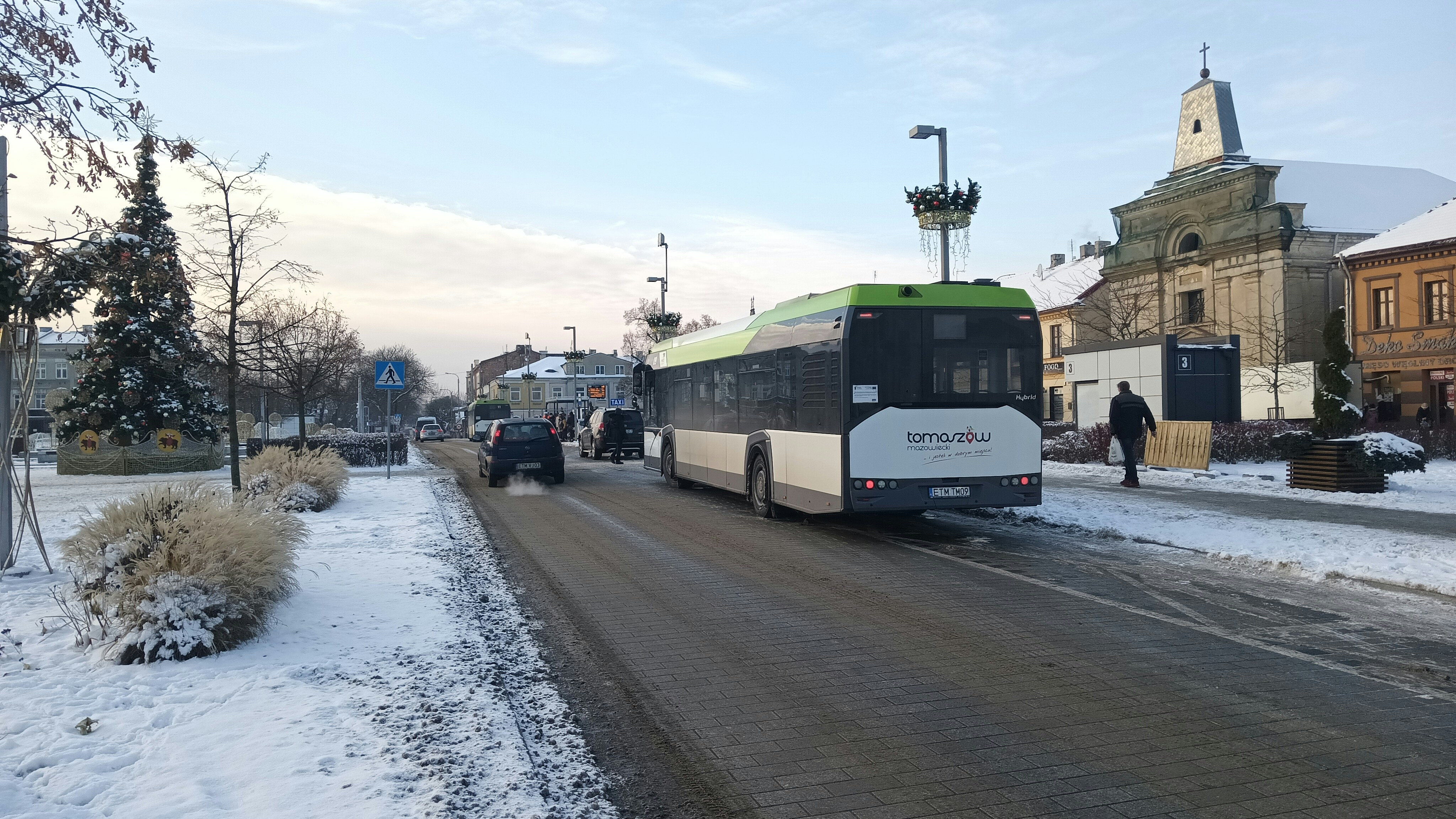 a bus driving down a snow covered road