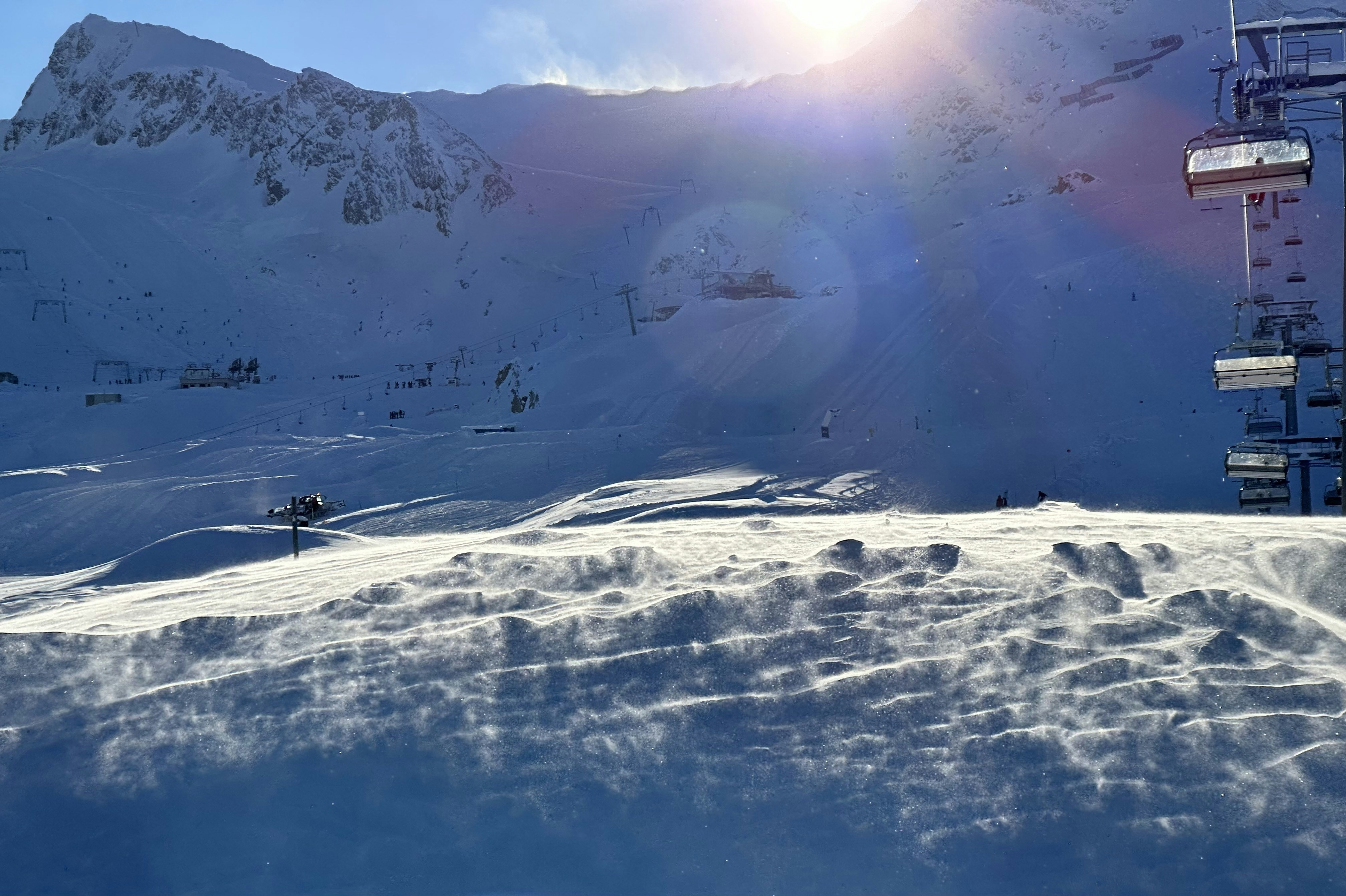 Halo Over Powder: A Sunlit Alpine Slopescape with a Silent Chairlift