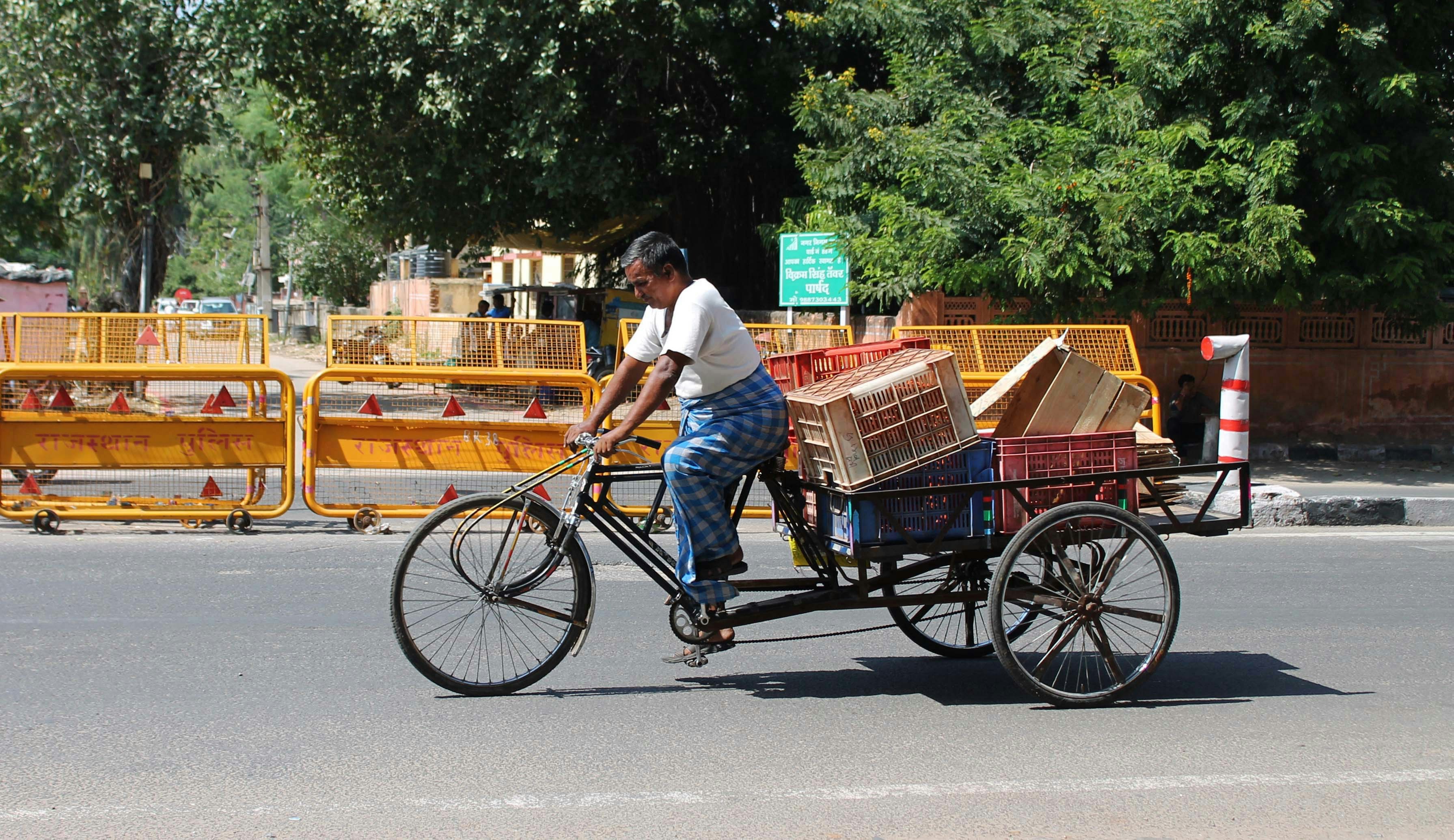 Cargobot on wheels: a cyclist hauling a busy street load