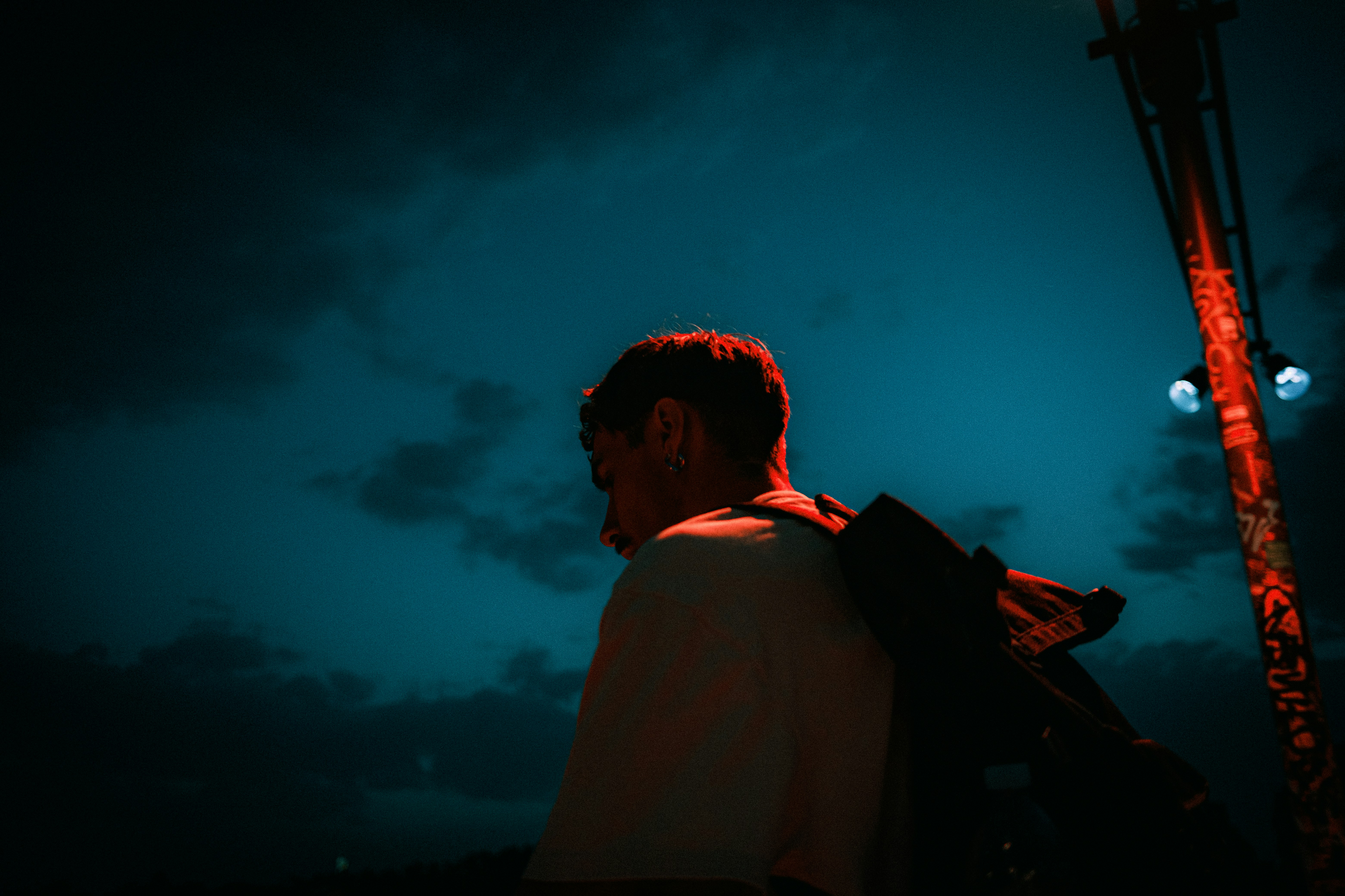 A man standing under a street light at night photo – Free Lighting ...