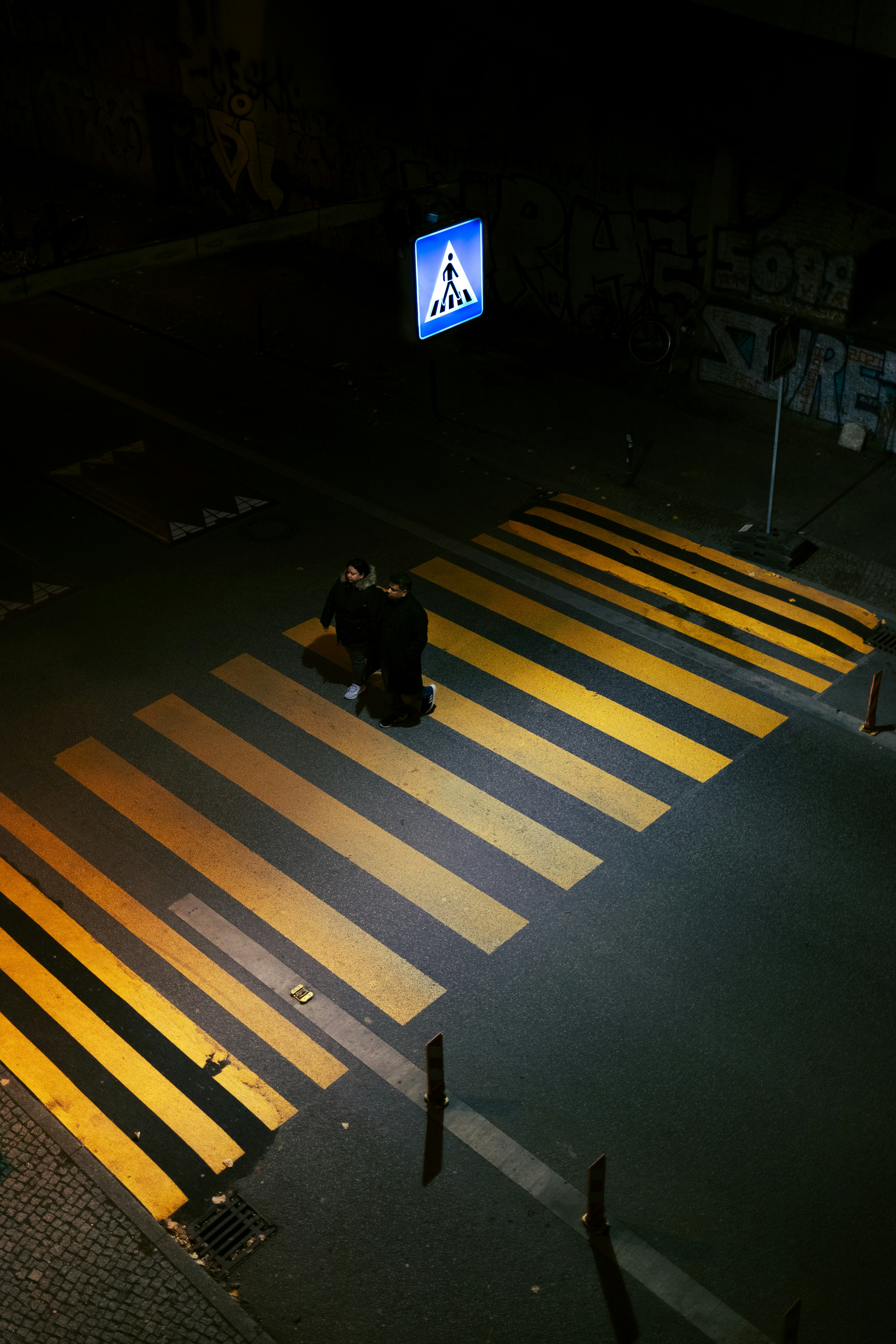 A person sitting on the ground in the middle of a crosswalk photo ...