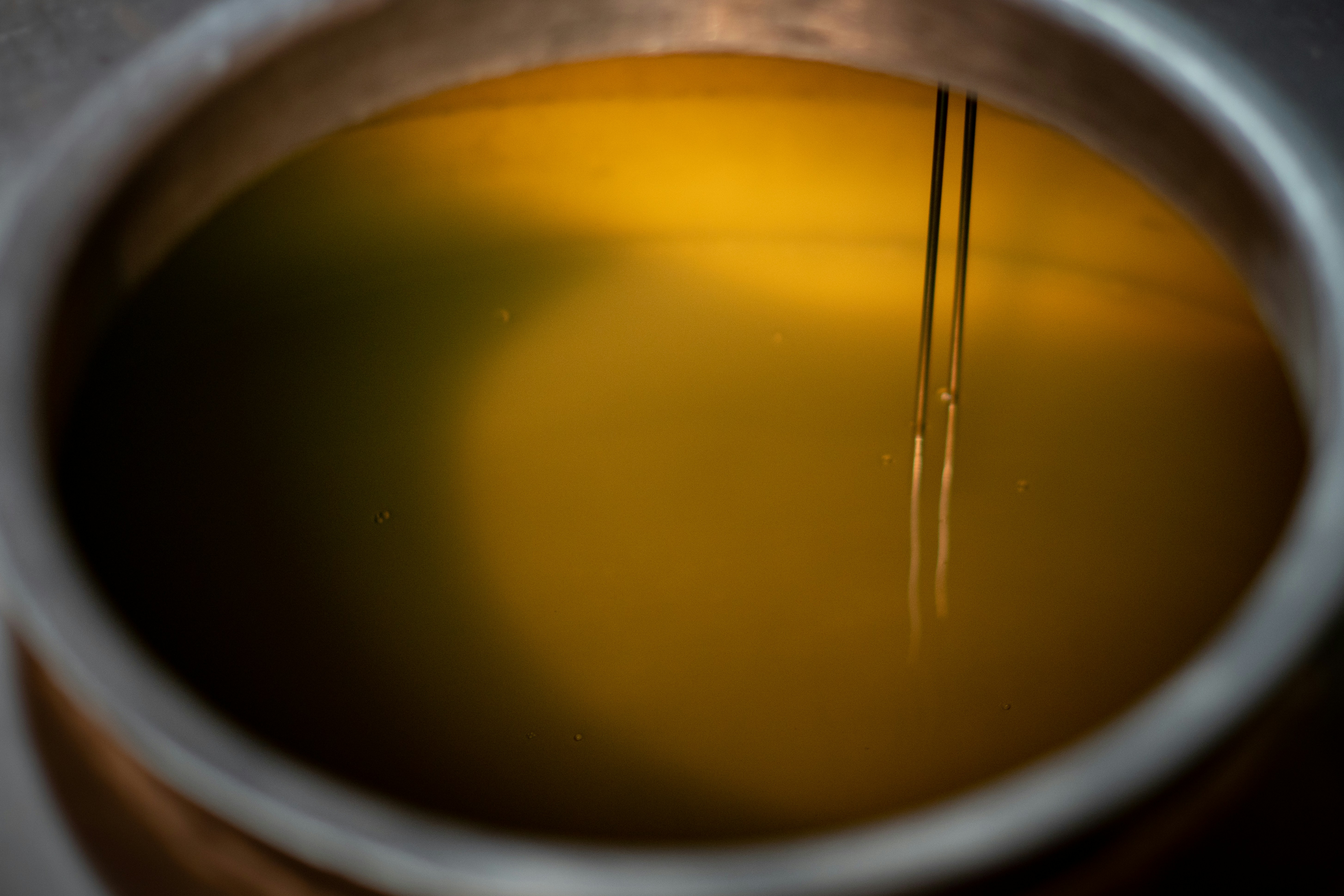 A close up of a cup of liquid with a straw sticking out of it photo ...