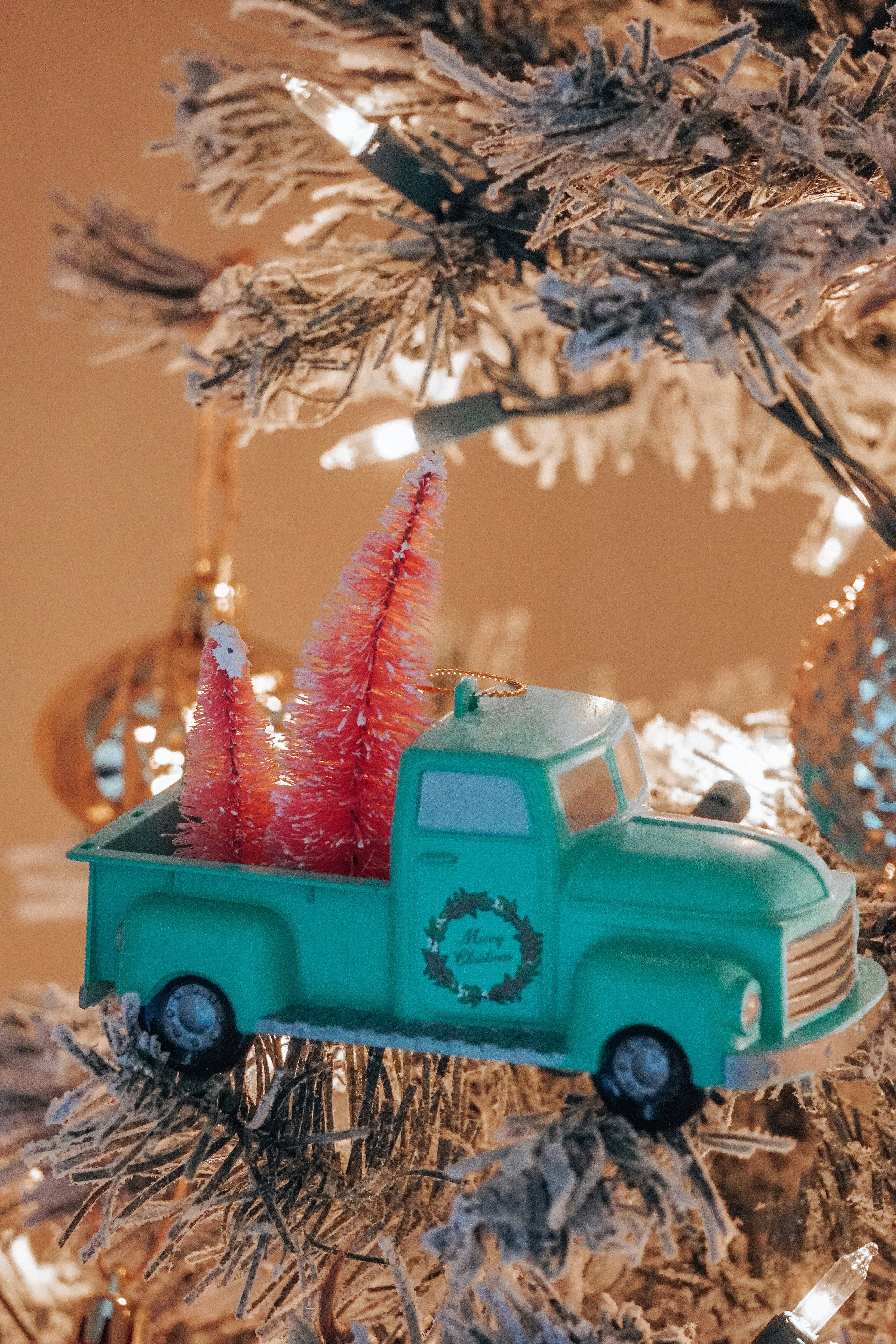 Mint-Tone Toy Truck Adorns Frosted Christmas Tree Under Warm Fairy Lights