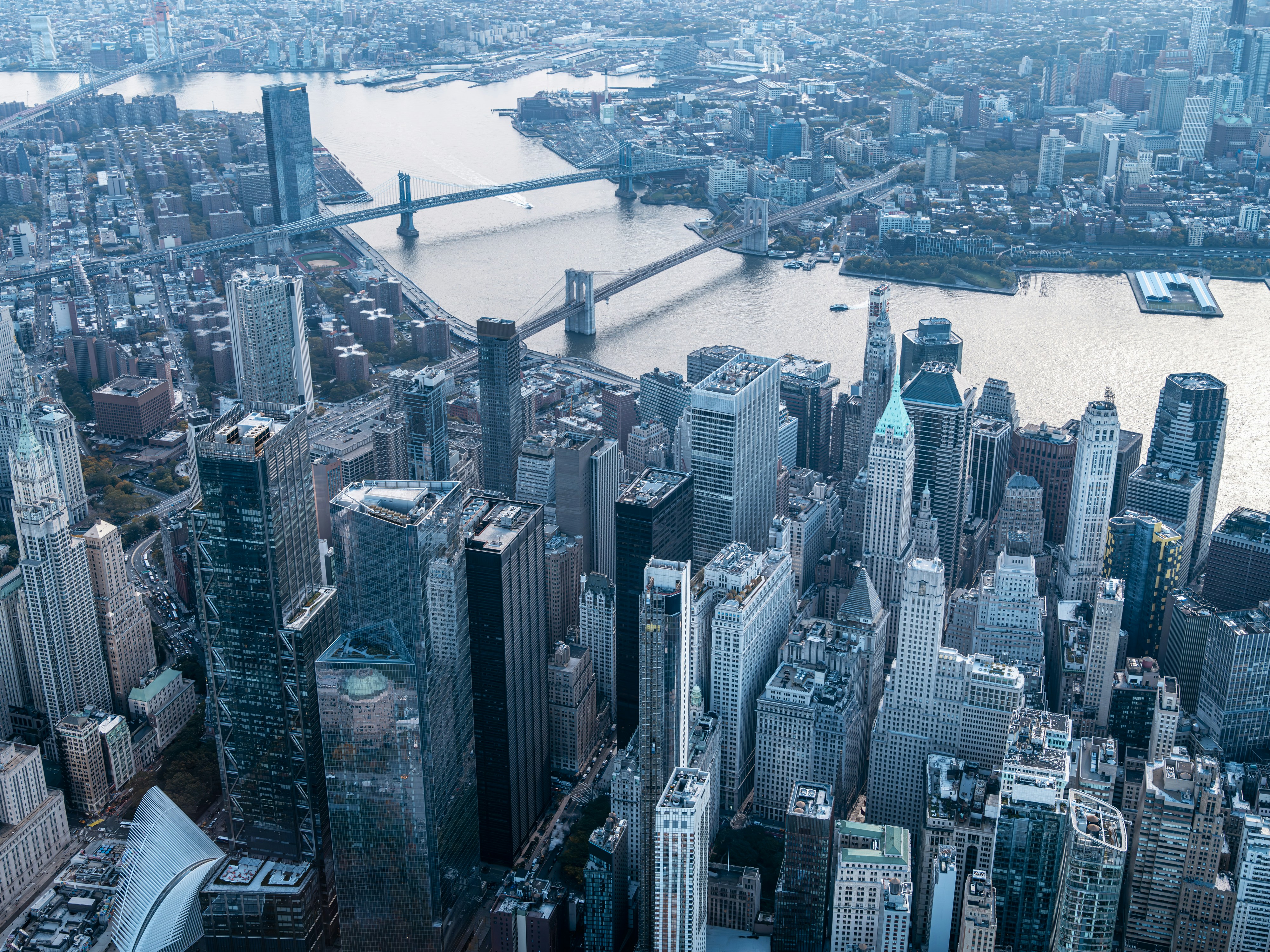 An aerial view of a city and a bridge photo – Free Manhattan Image on ...
