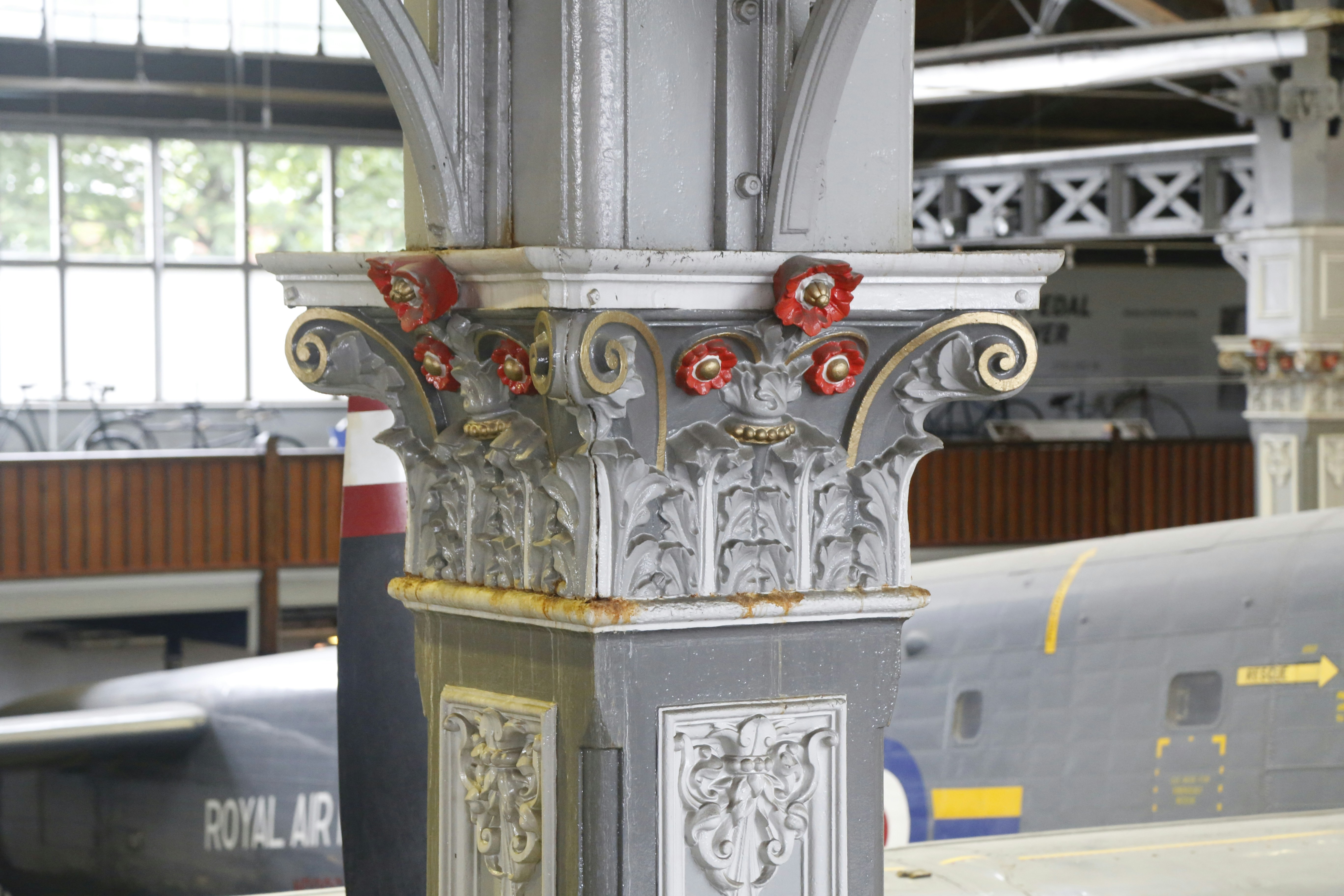 A pillar in a building with a train in the background photo – Free ...