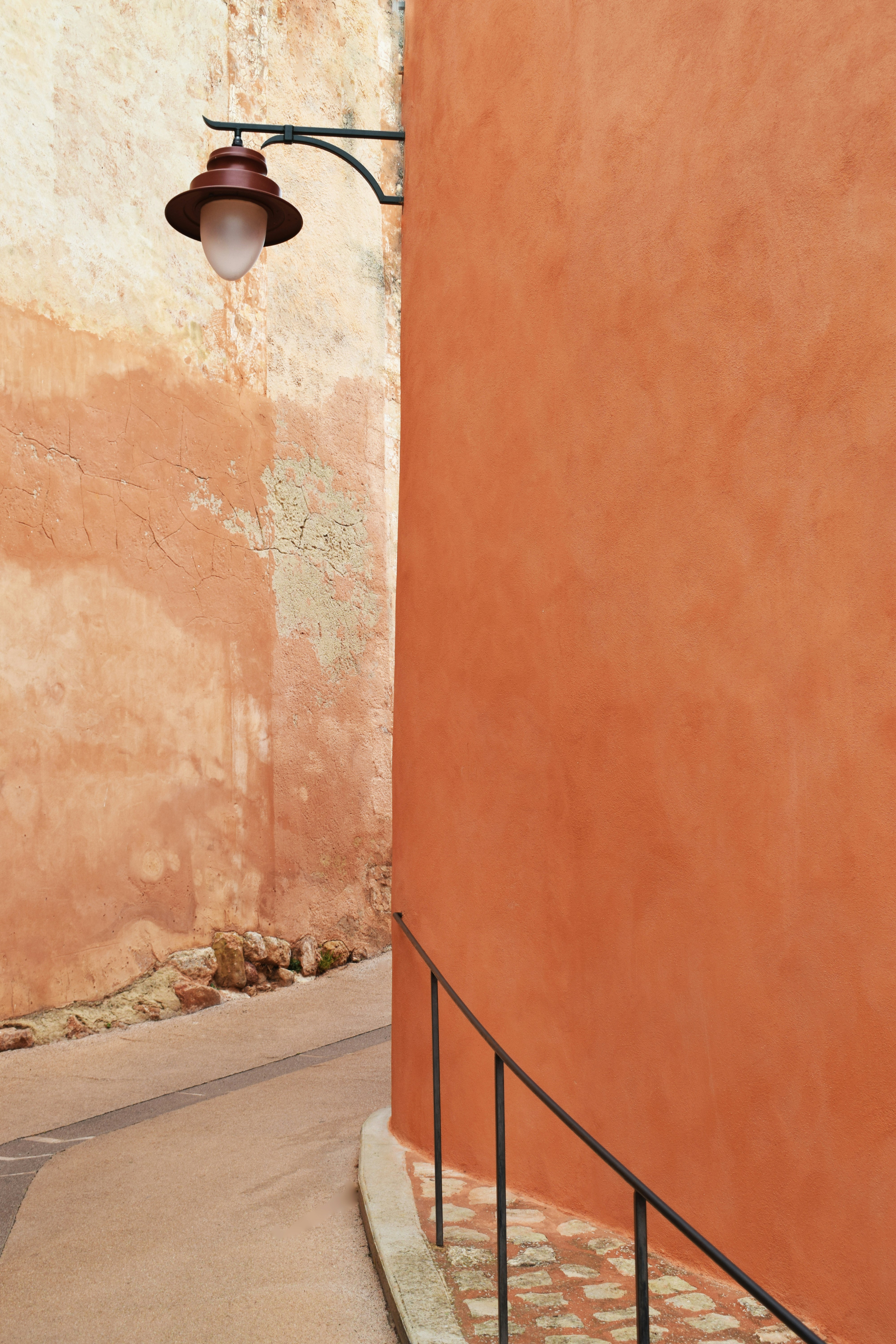 Terracotta Passage: A Winding Staircase Between Warm Walls