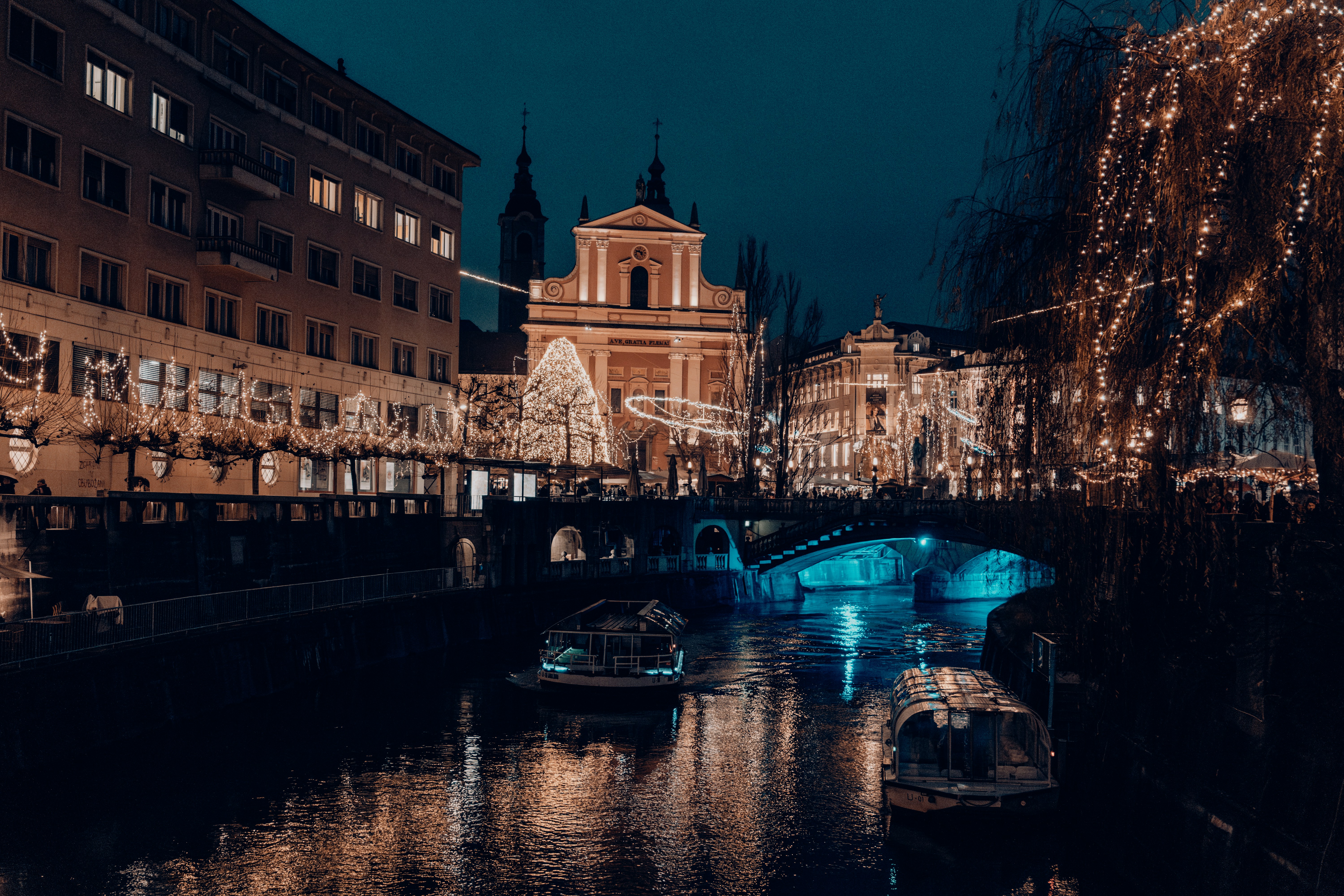 Nocturnal Canal Reverie: Reflections, Boats, and a Lit Cathedral