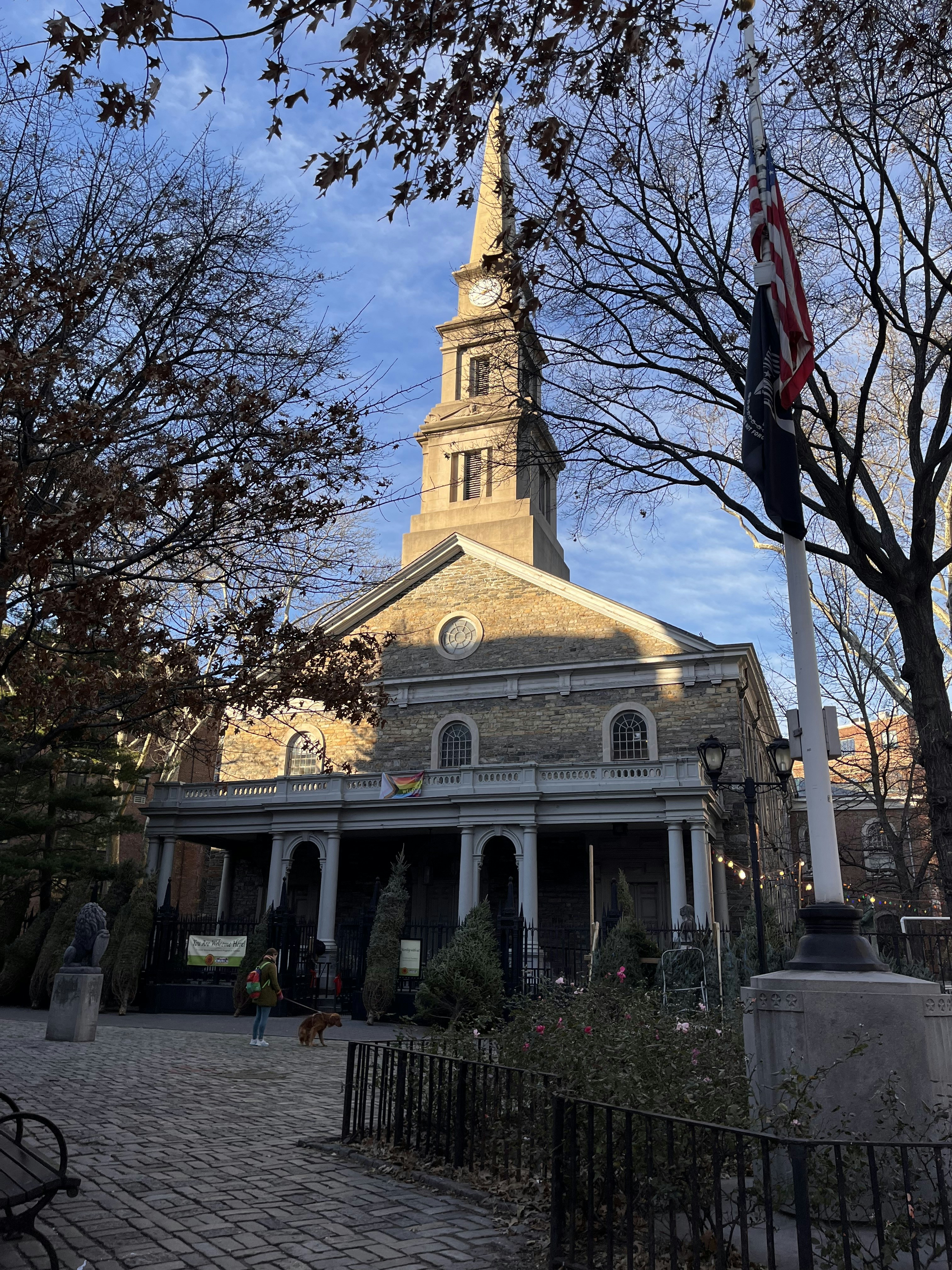 A building with a steeple and a flag on top of it photo – Free Tower ...
