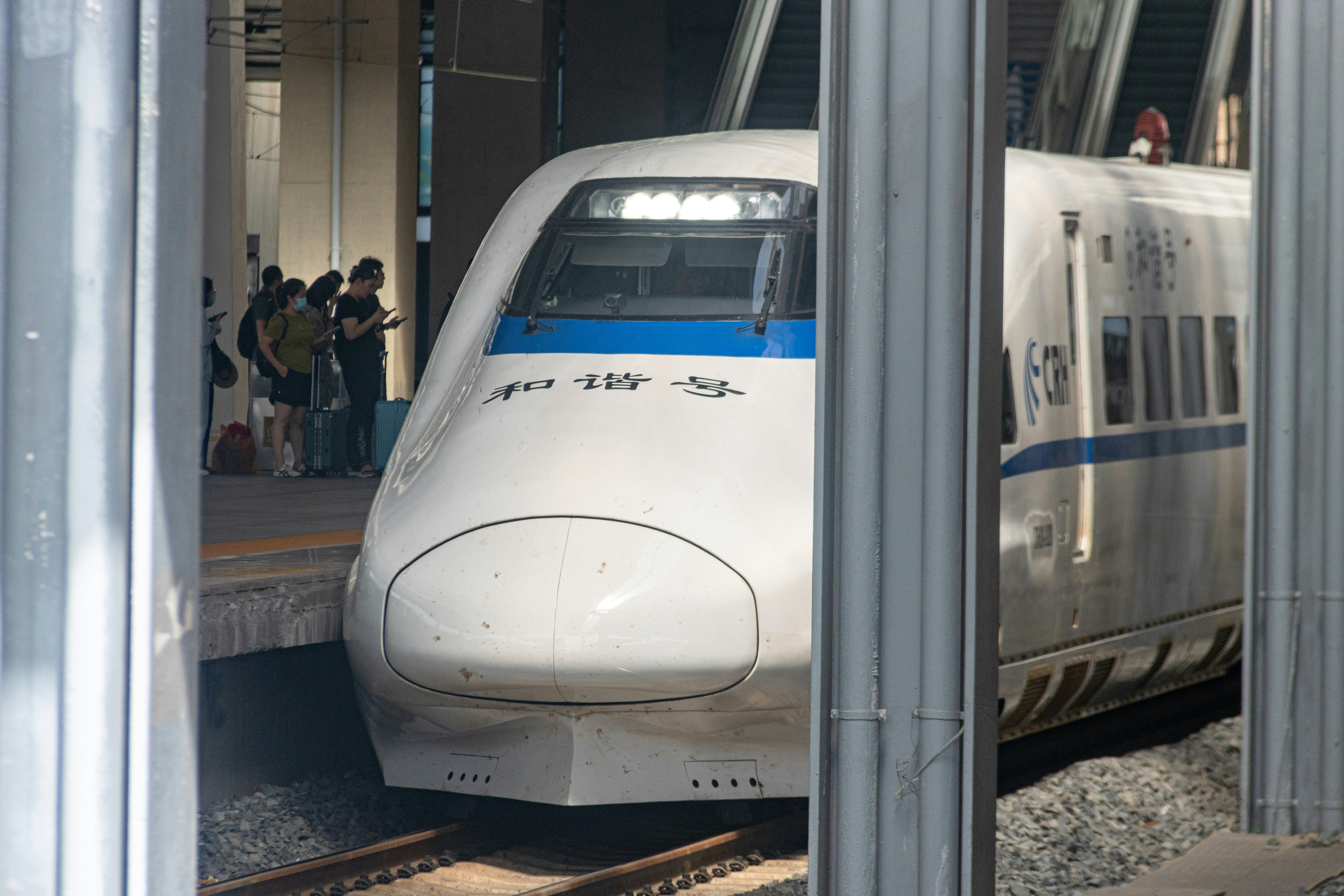 A white and blue train traveling down train tracks photo – Free Railway ...