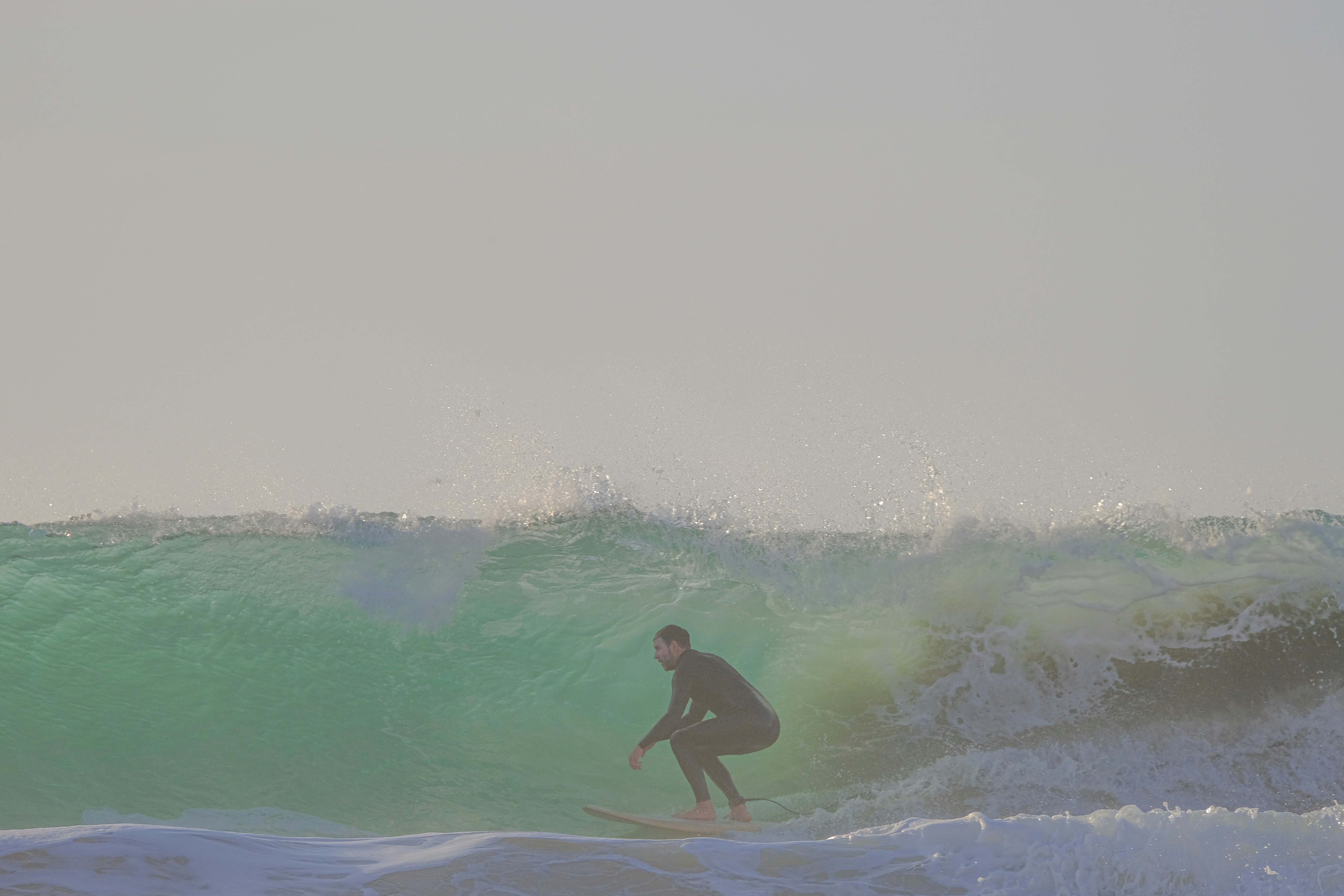 Emerald Crest Rider: Balance Within a Glassy Green Wave
