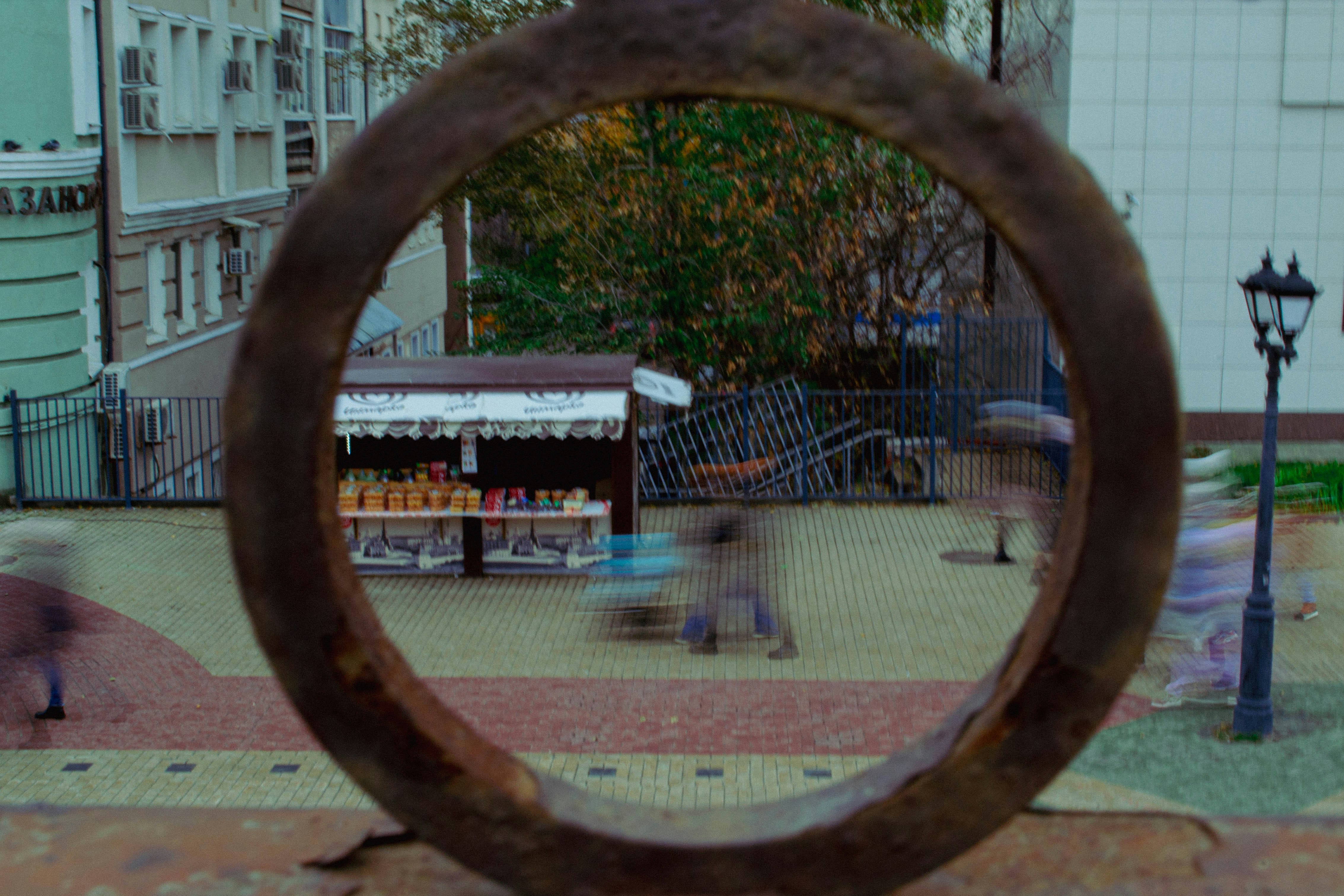 a view of a park through a circular object