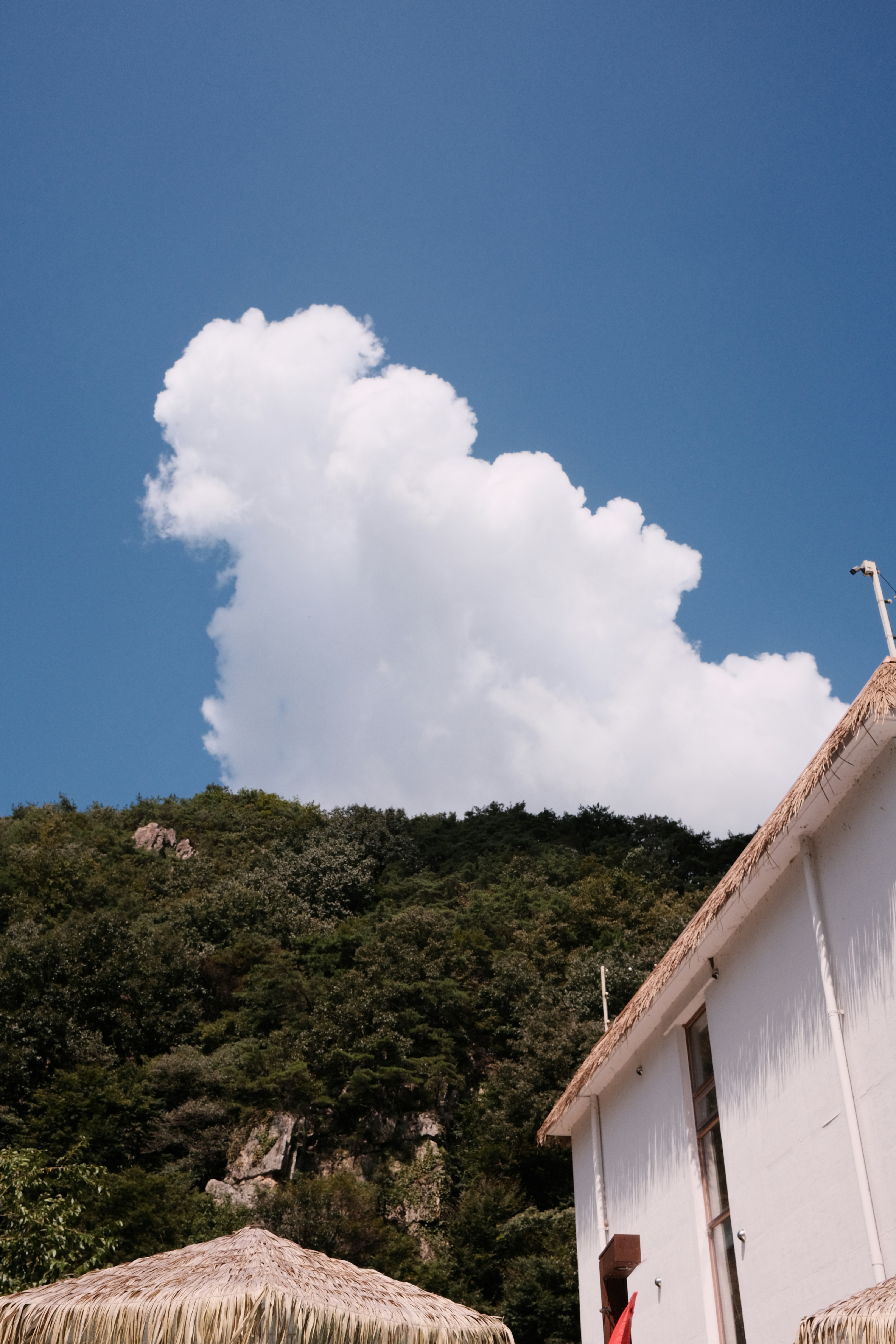 Cloud Over White-Walled Cottage