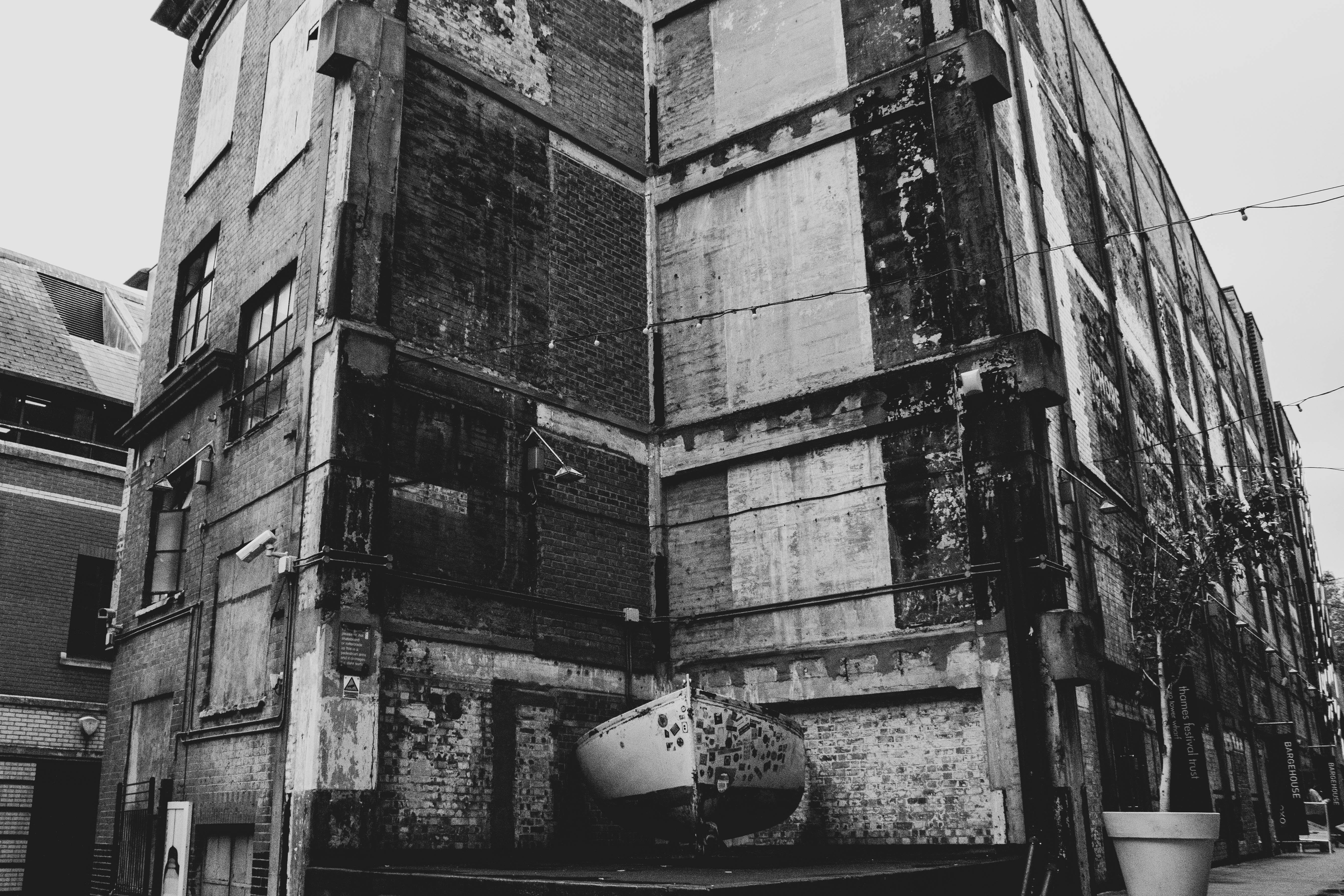Monochrome Monolith: Weathered Brick Facade of a Silent Industrial Block