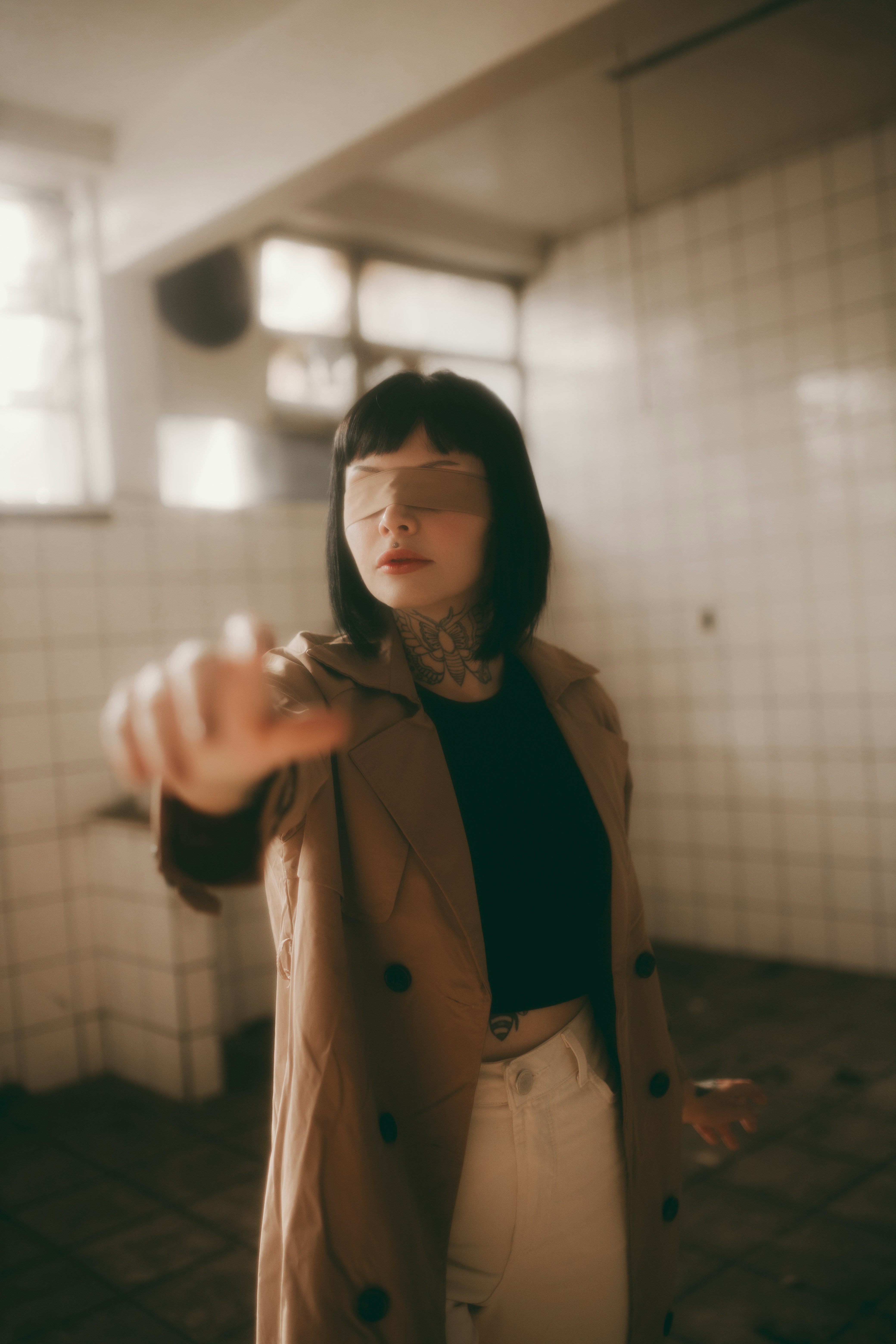 A woman with blindfolded eyes standing in a bathroom photo – Free Coat ...