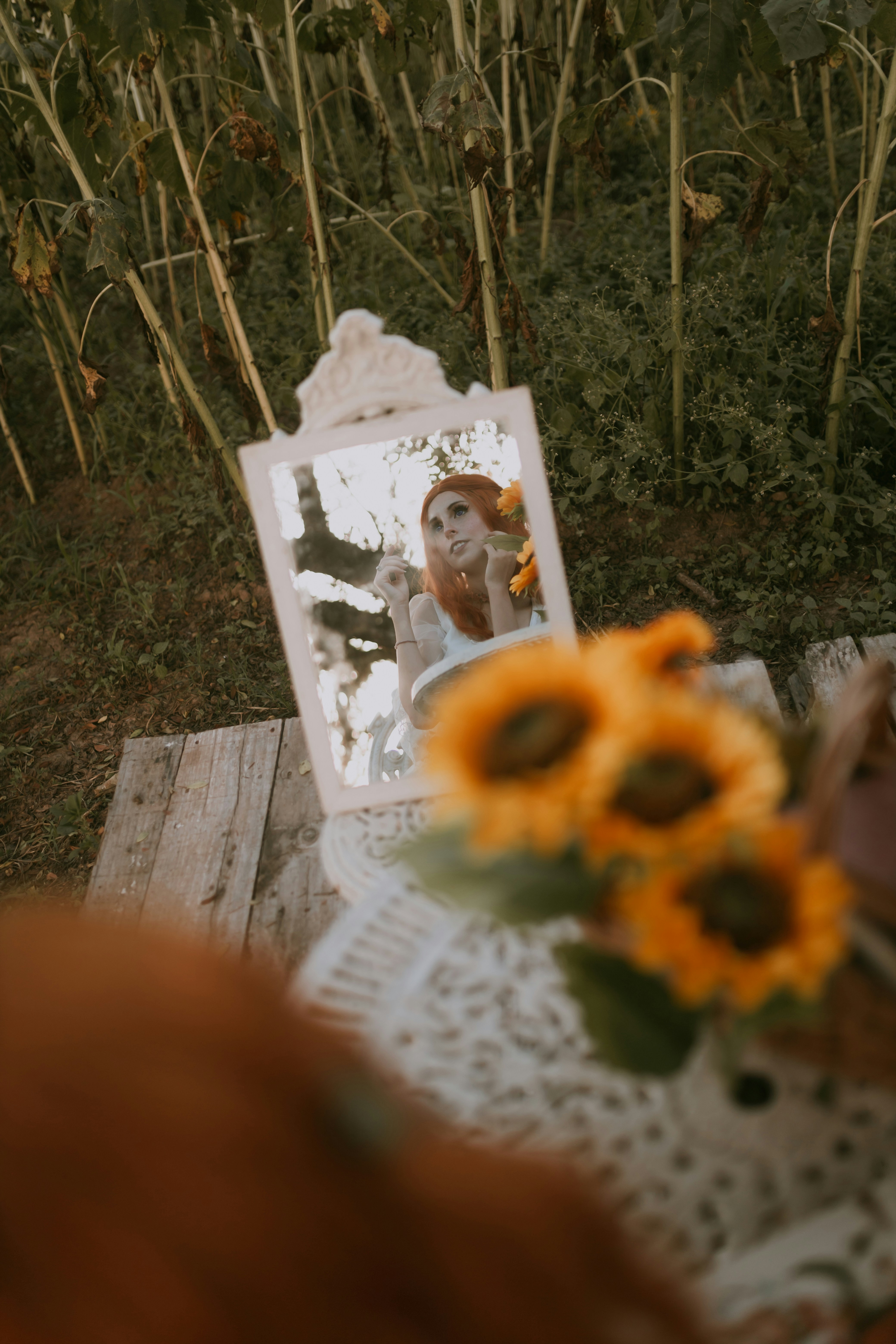 Reflected Moment: A Quiet Portrait Framed by Sunflowers