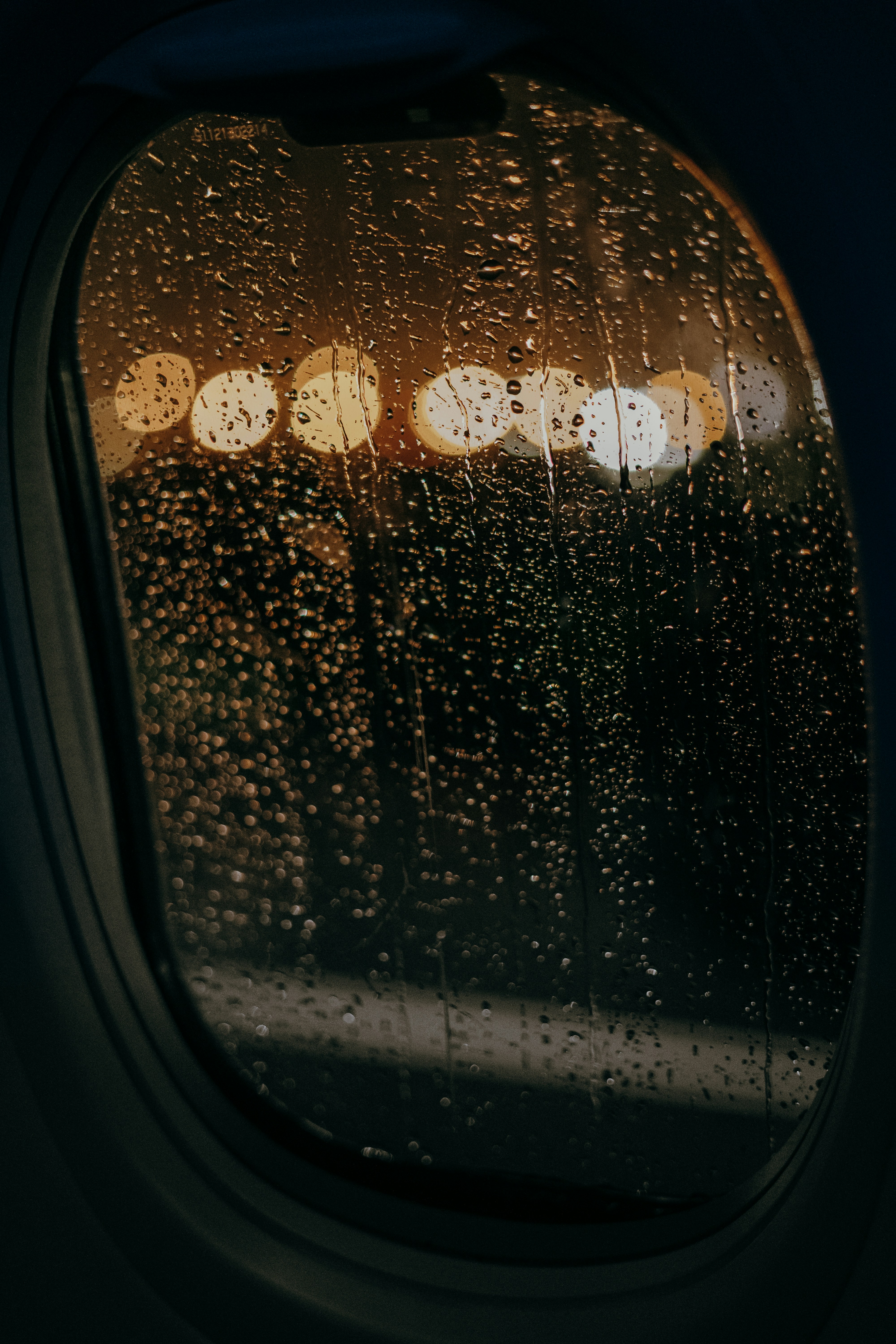 Rain-Kissed Pane: City Lights Bloom Through Veiled Droplets