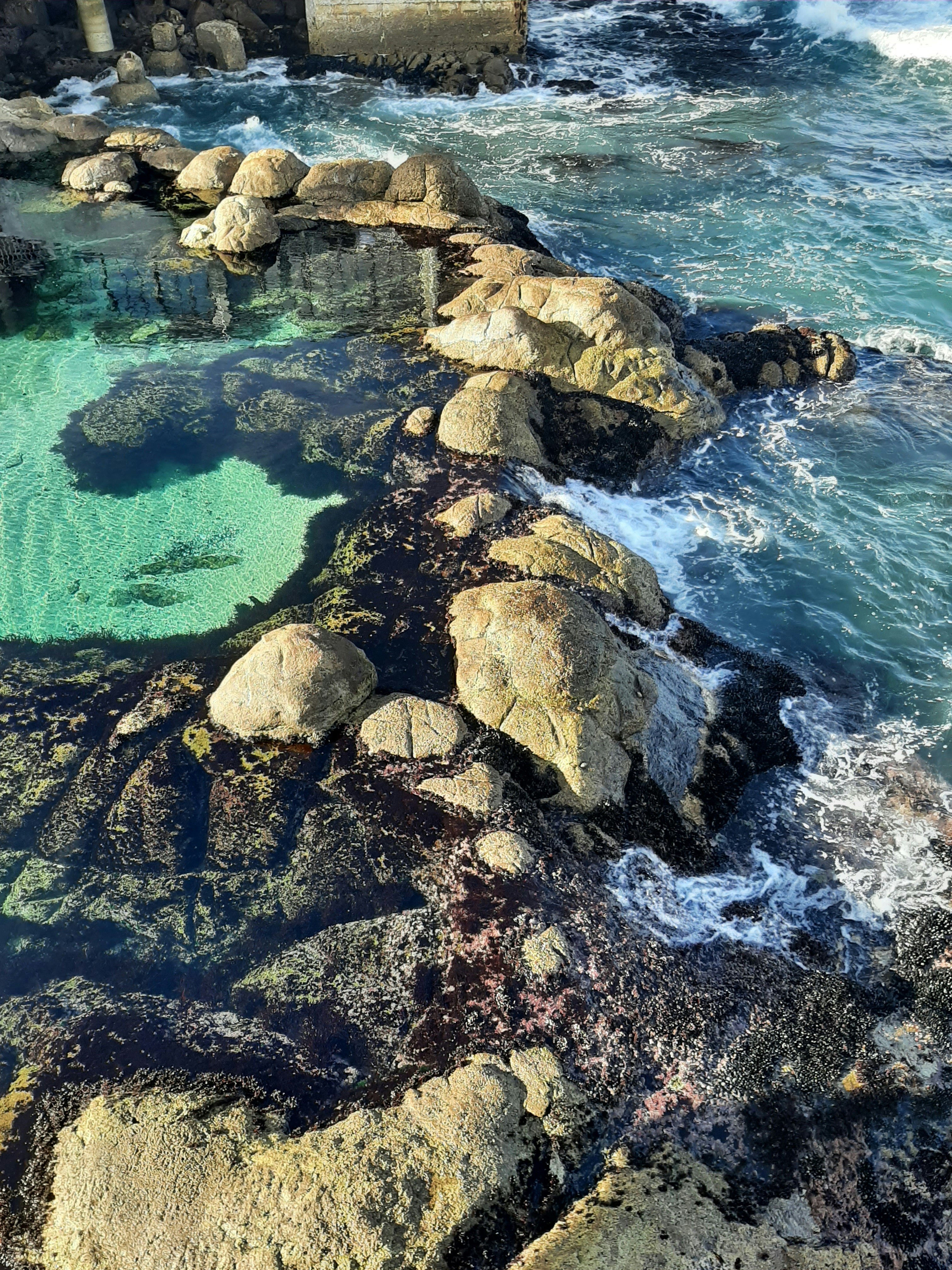 A large body of water surrounded by rocks photo – Free Monterey bay ...