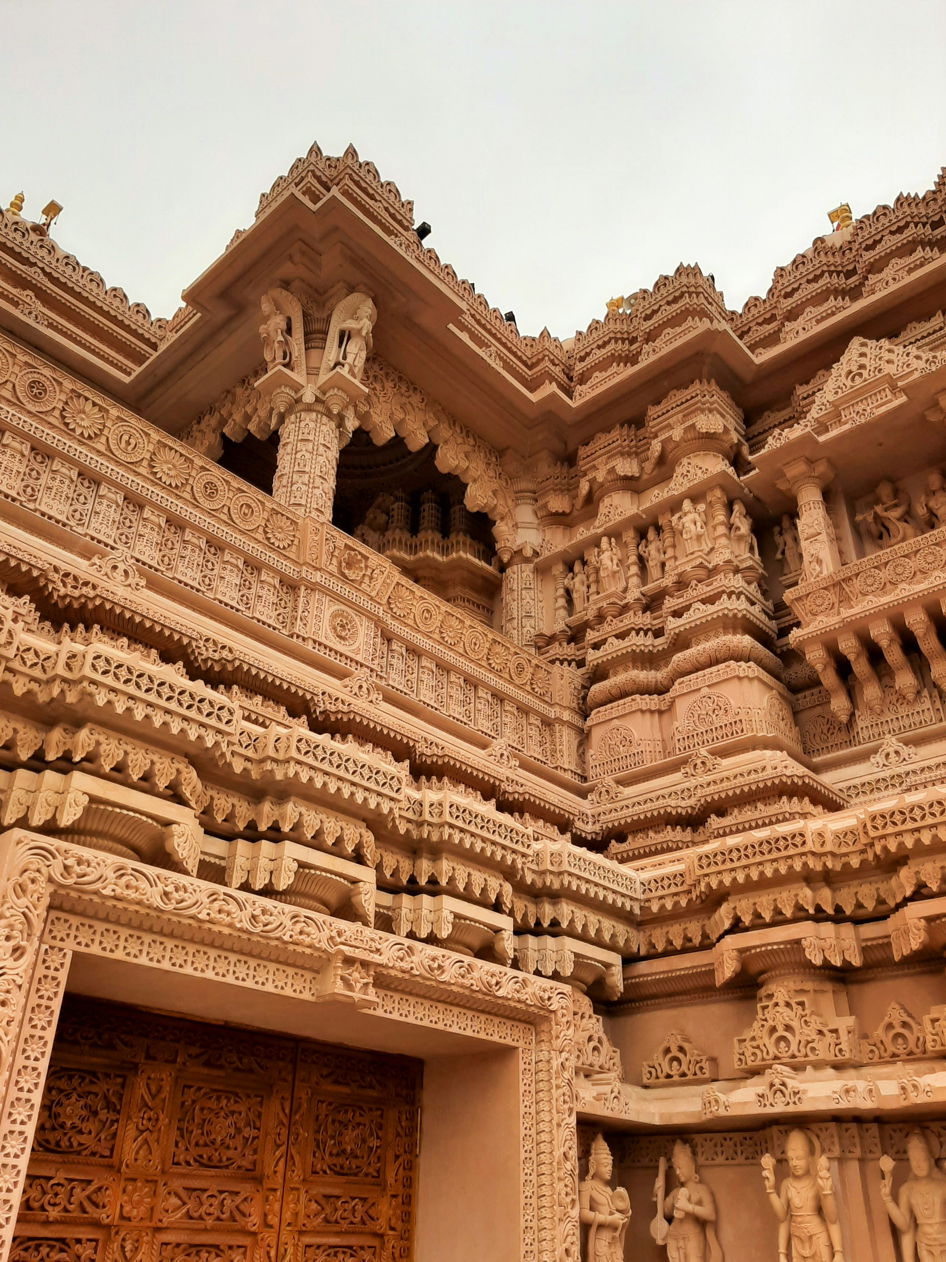 An intricately carved building with a wooden door photo – Free ...