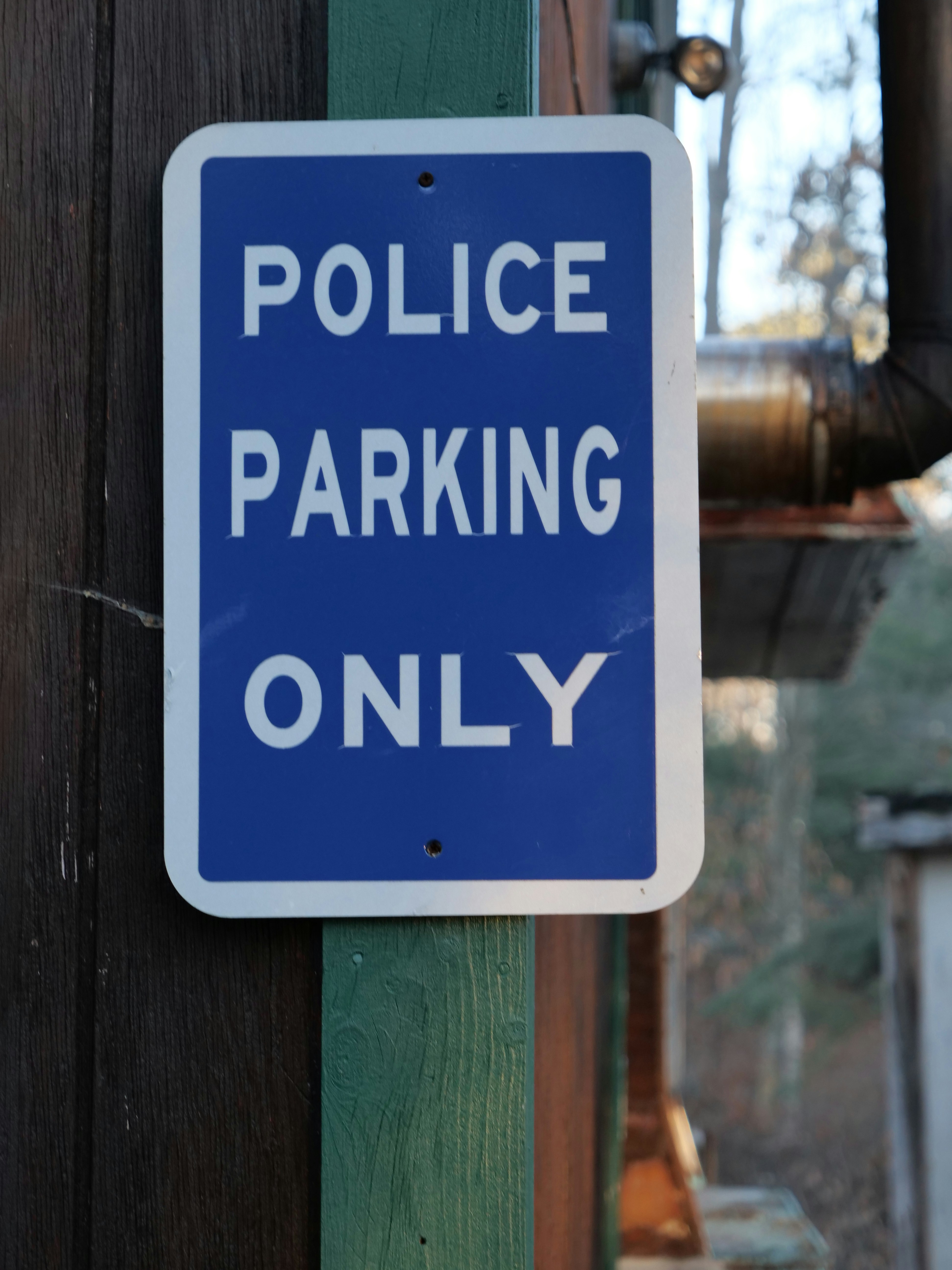 A police parking only sign attached to a telephone pole photo – Free ...