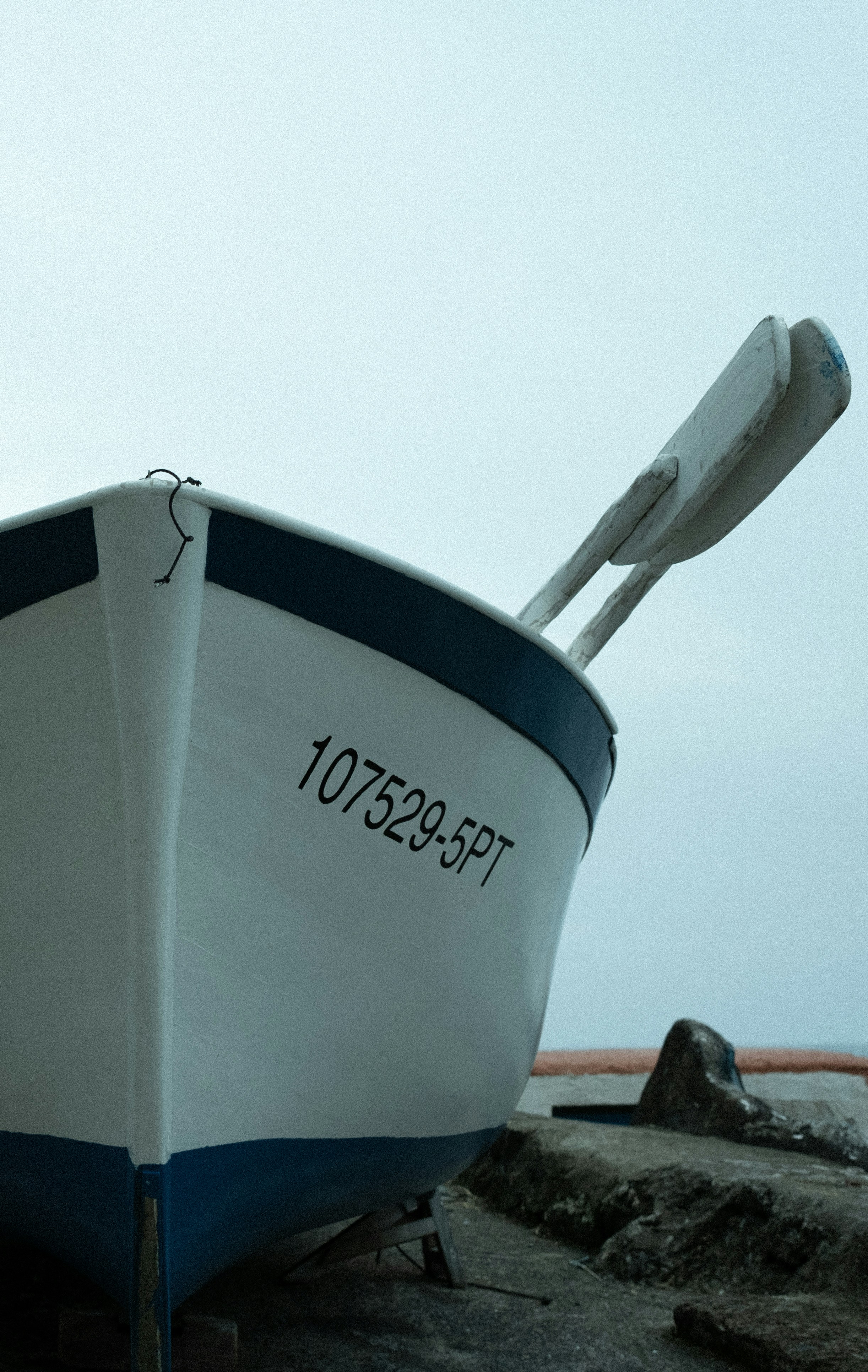 Bow Beached: A Quiet Vessel Resting on Blue and White
