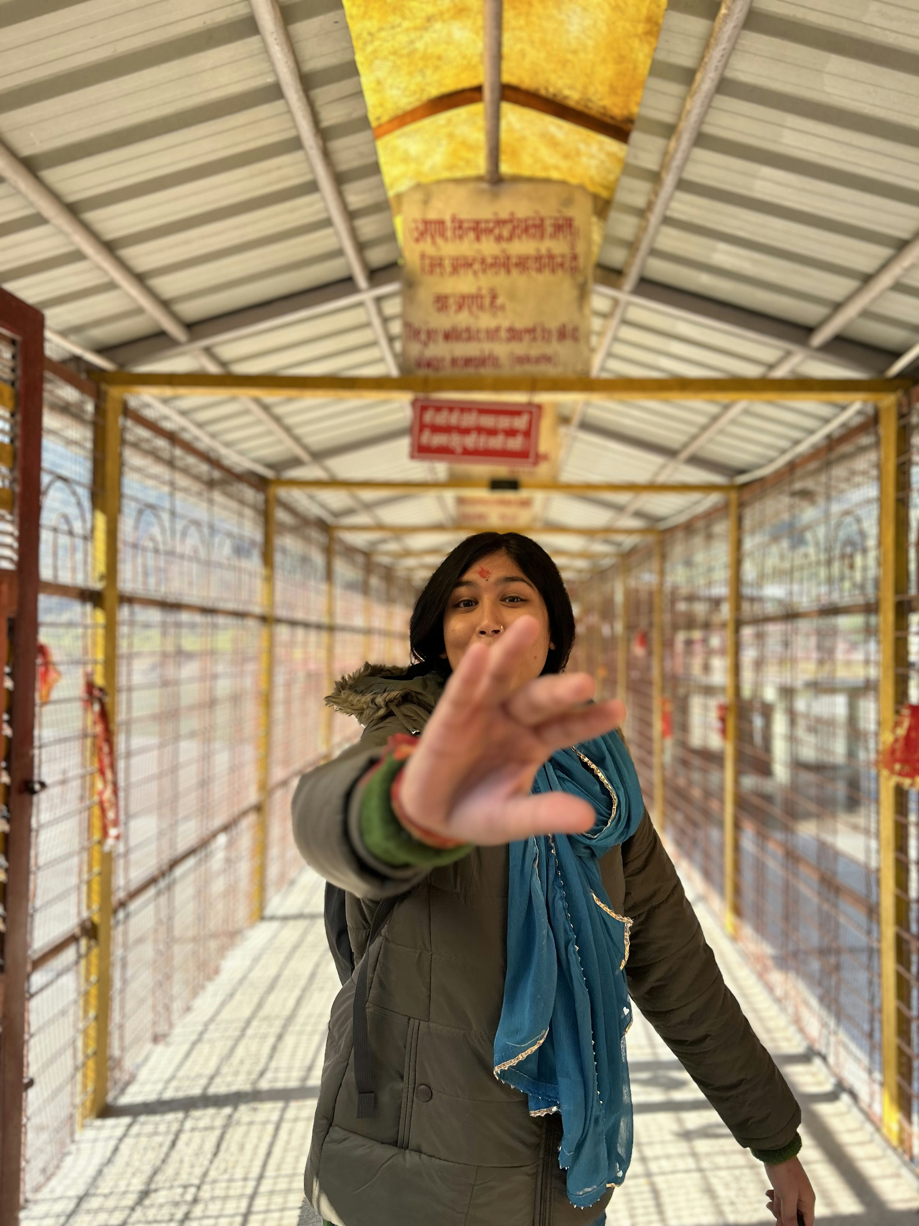 Reach and Focus: A Portrait Framed by a Metal-Grid Corridor