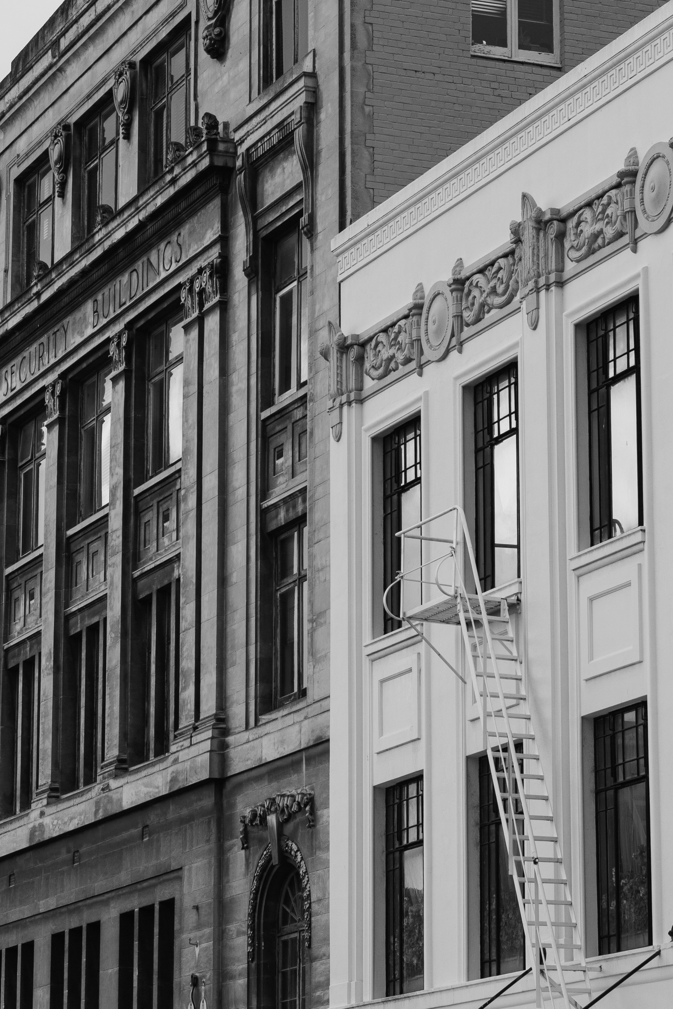 A black and white photo of a building with a fire escape photo – Free ...