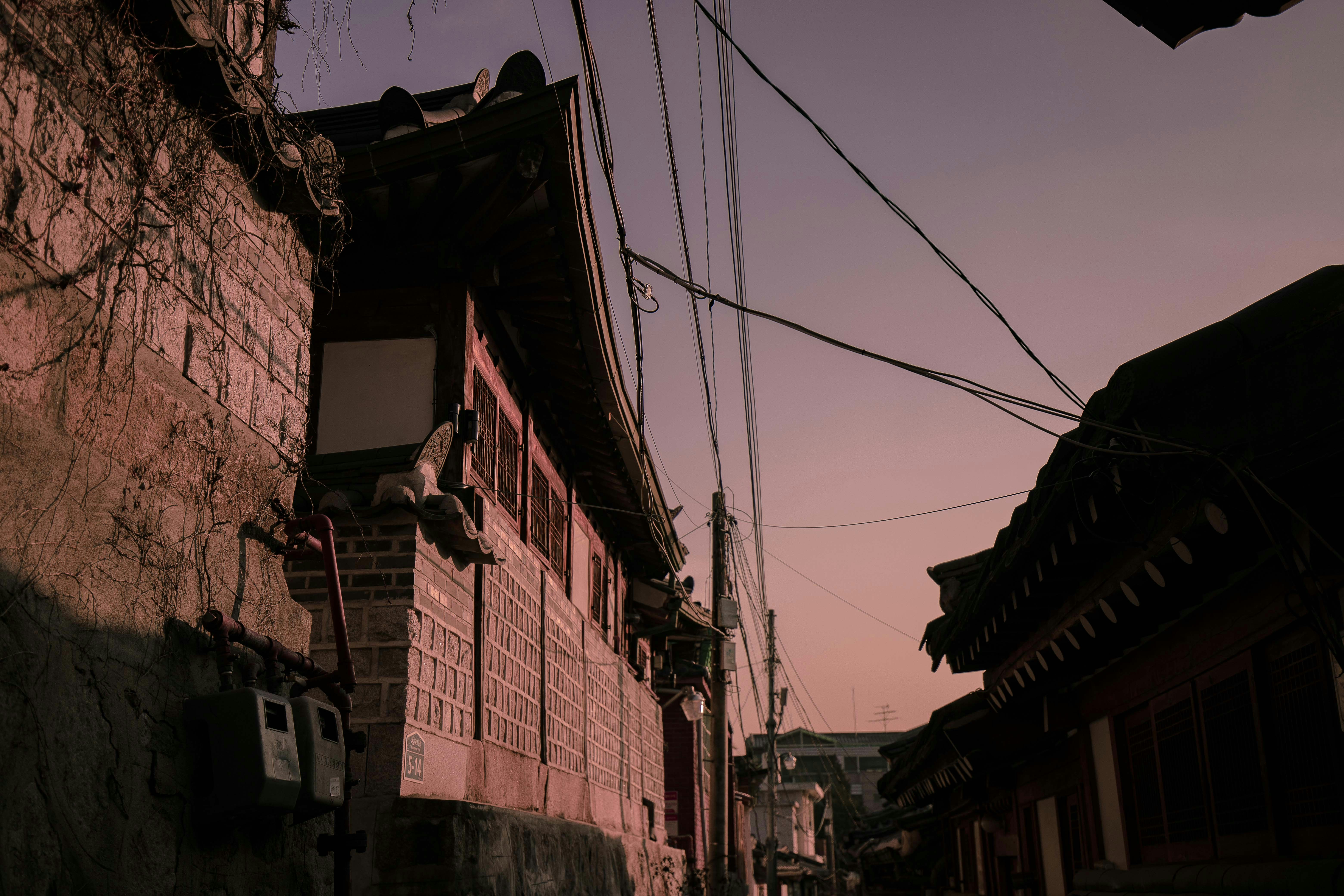 Dusk over the Lantern Alley: Narrow Street Between Timeless Rooflines