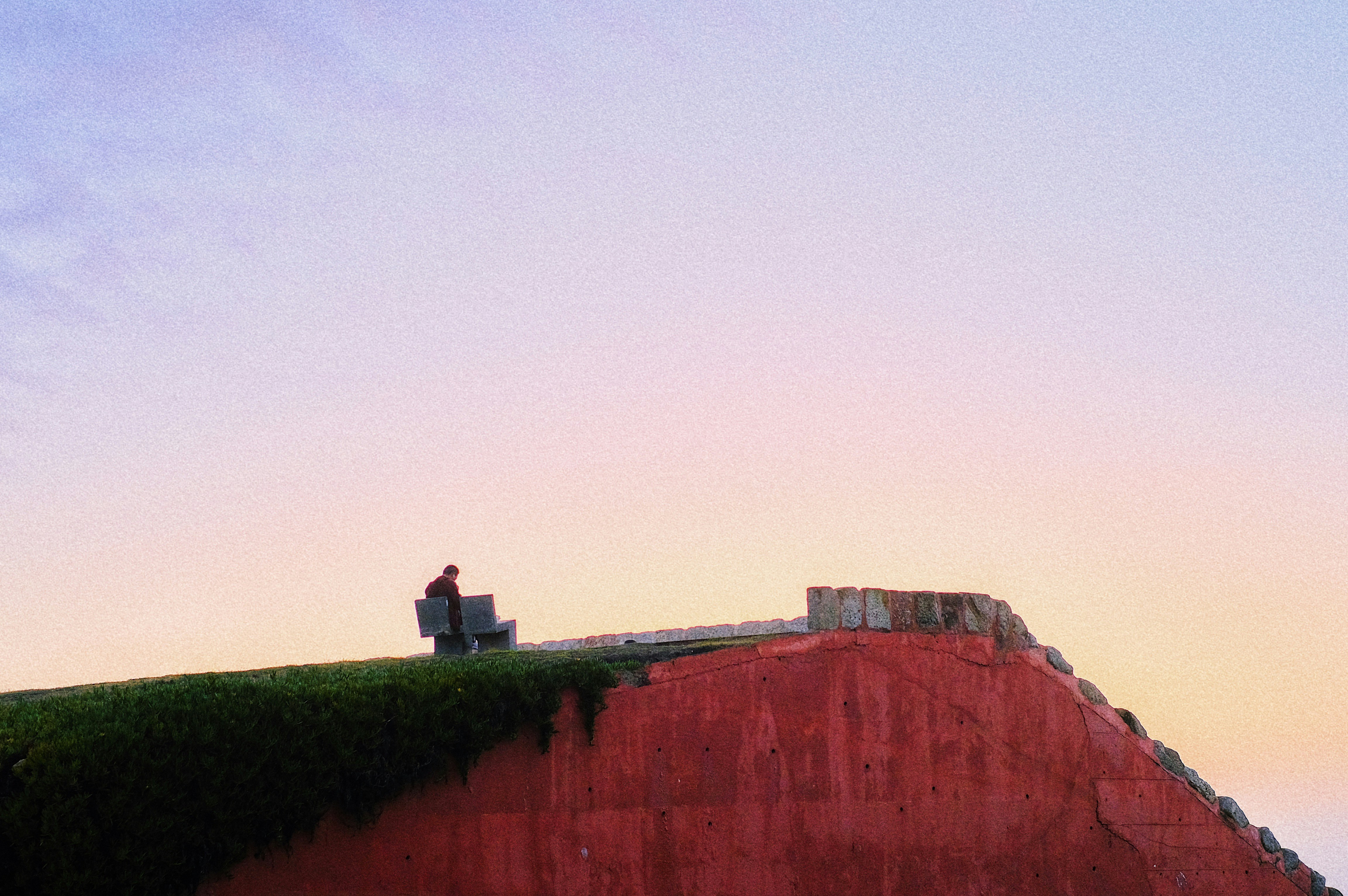 Solitary Figure on a Distant Crest at Dusk