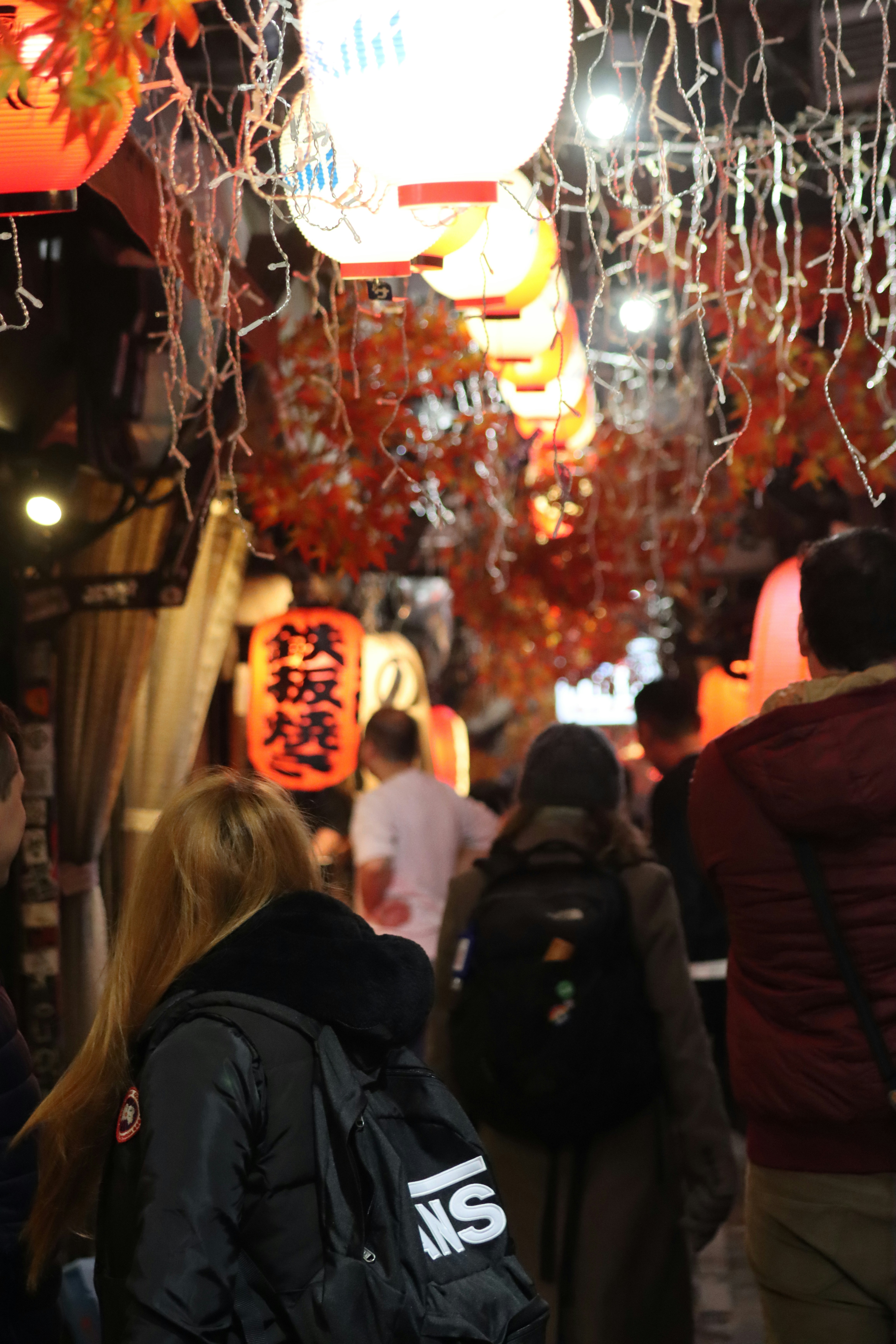 Lantern-Lined Night Market: A Crowd Wades Through Warm Festival Glow