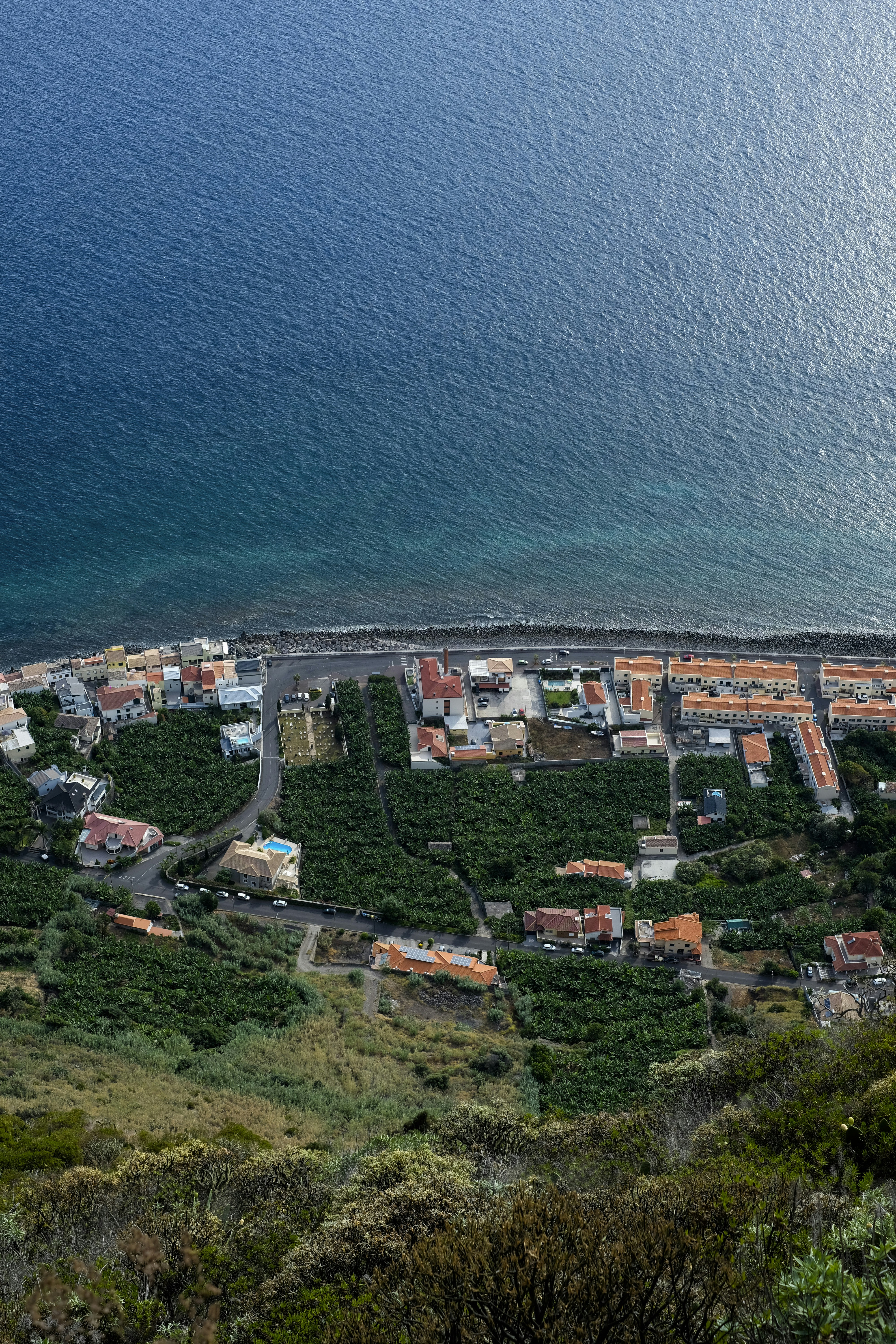 Terracotta Roofline Cascades to the Quiet Blue Shore