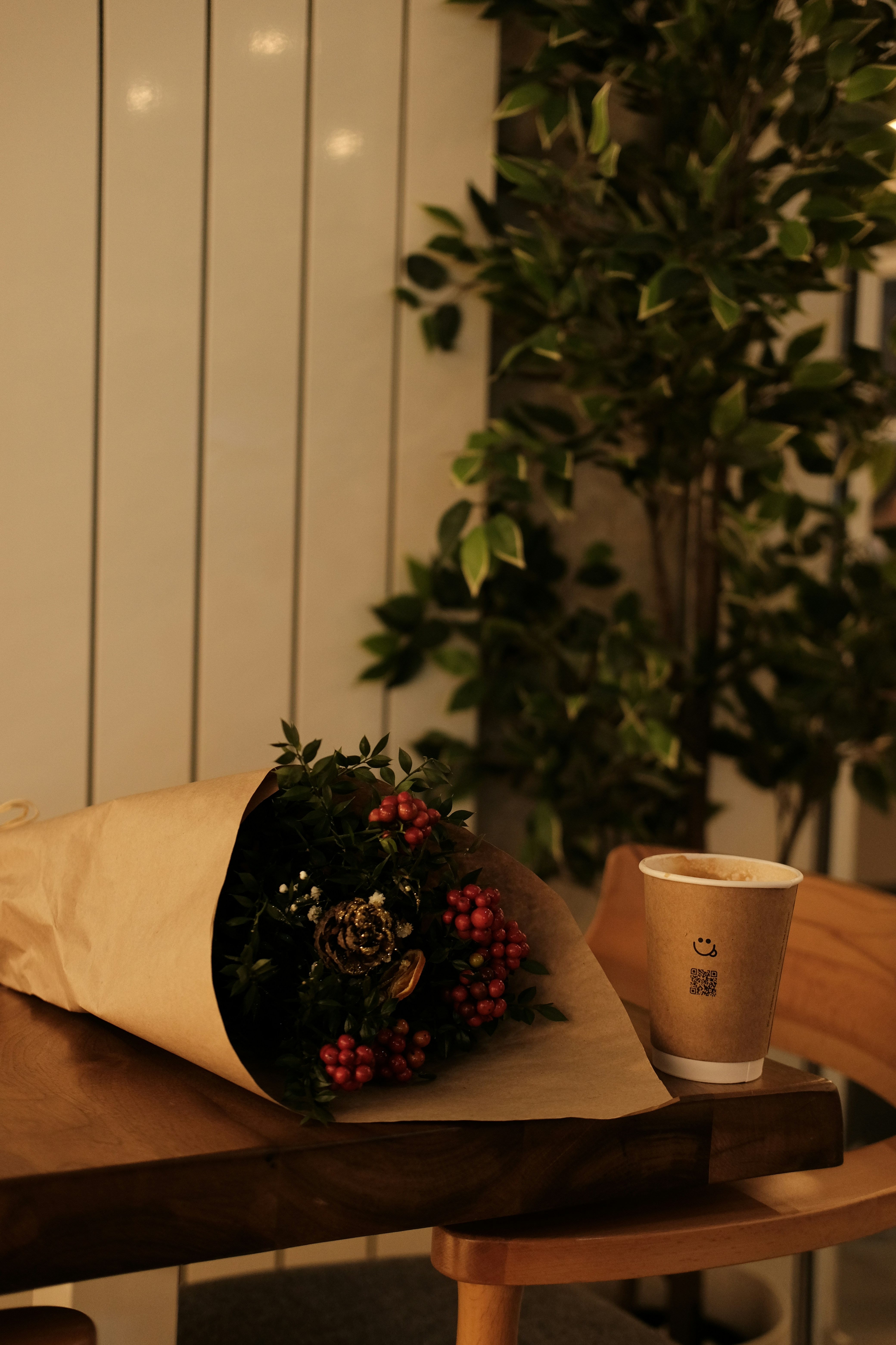 Bouquet by the Coffee Cup: A Quiet Moment on the Wooden Table