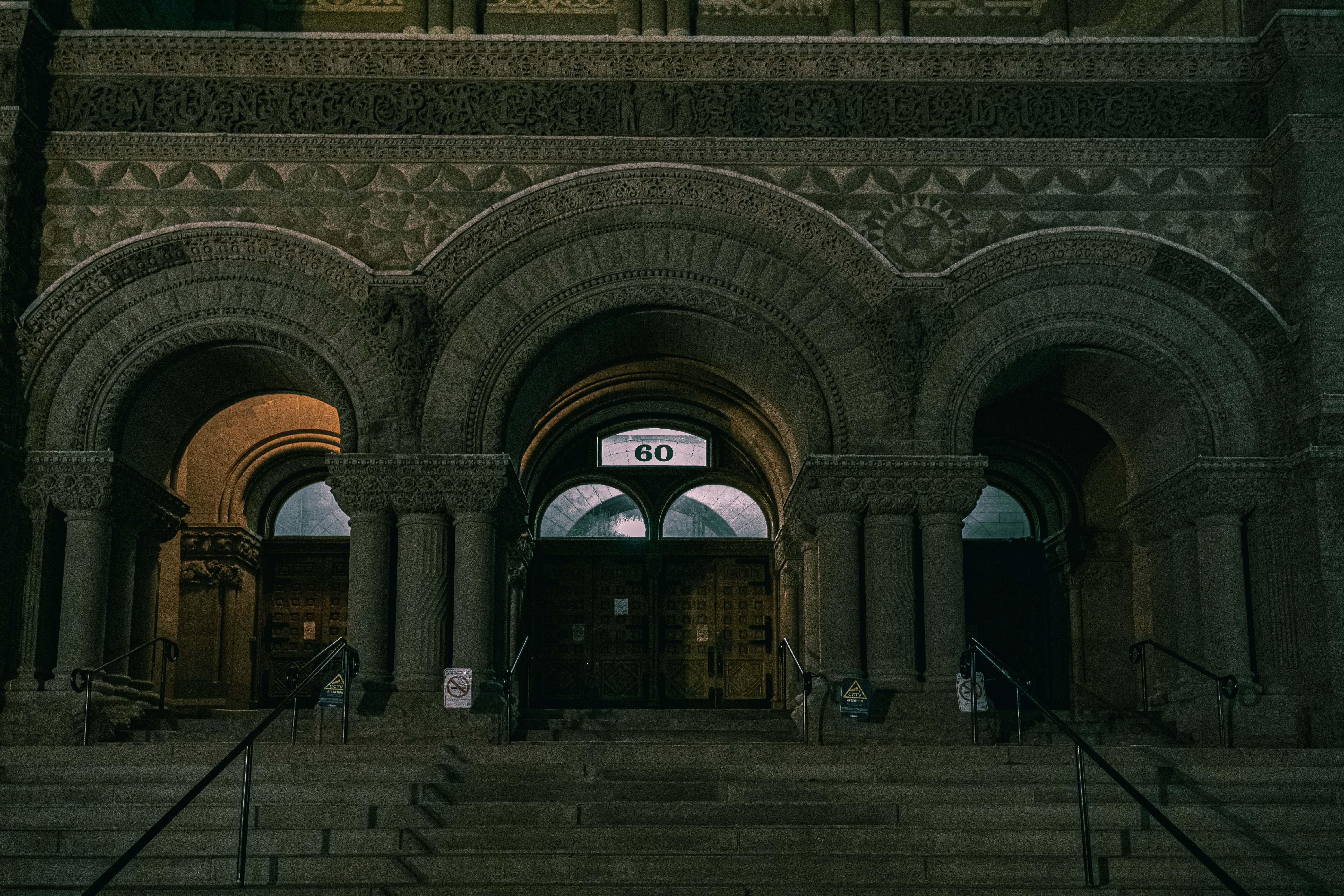 Lamplit Arch at the Center: Stone Stairs Framing a Quiet Doorway