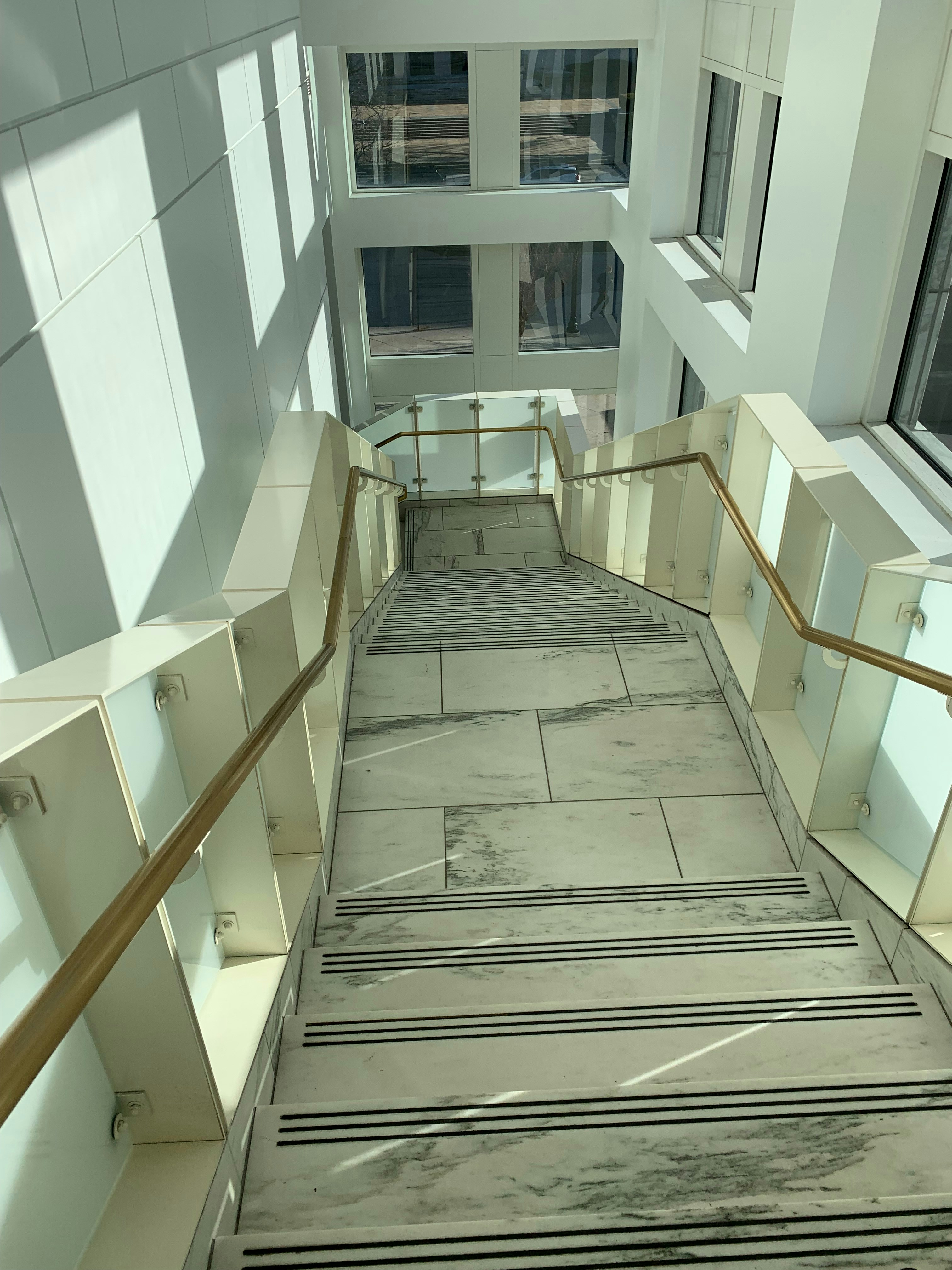 Stairwell Through Glass: Descending Lines Toward Daylight