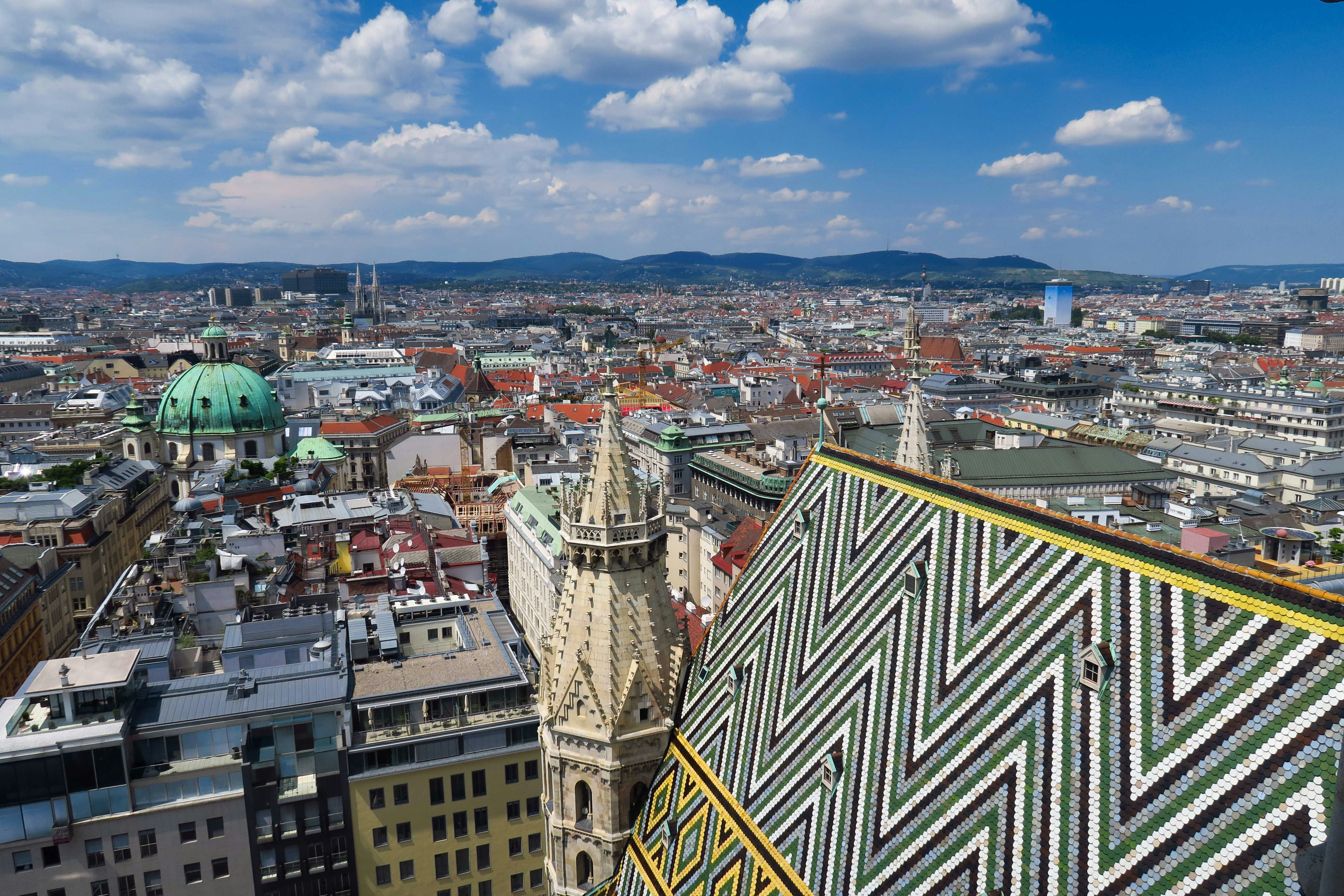 Vibrant rooftops and architectural details of Vienna captured from a high vantage point, showcasing the city's rich history and modern skyline.