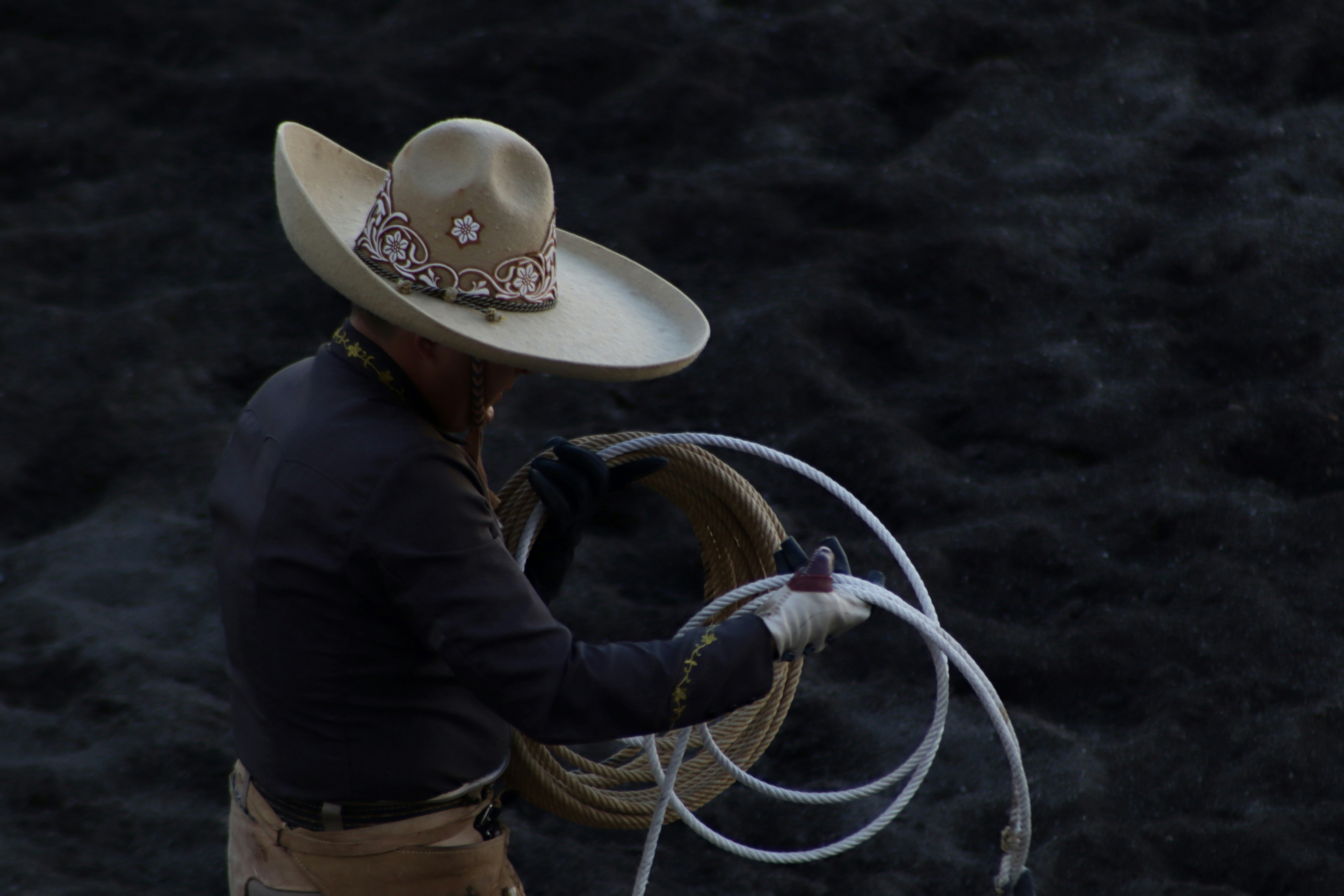 Shadowed Lariat: A Cowboy Tightens the Loop in Low Light