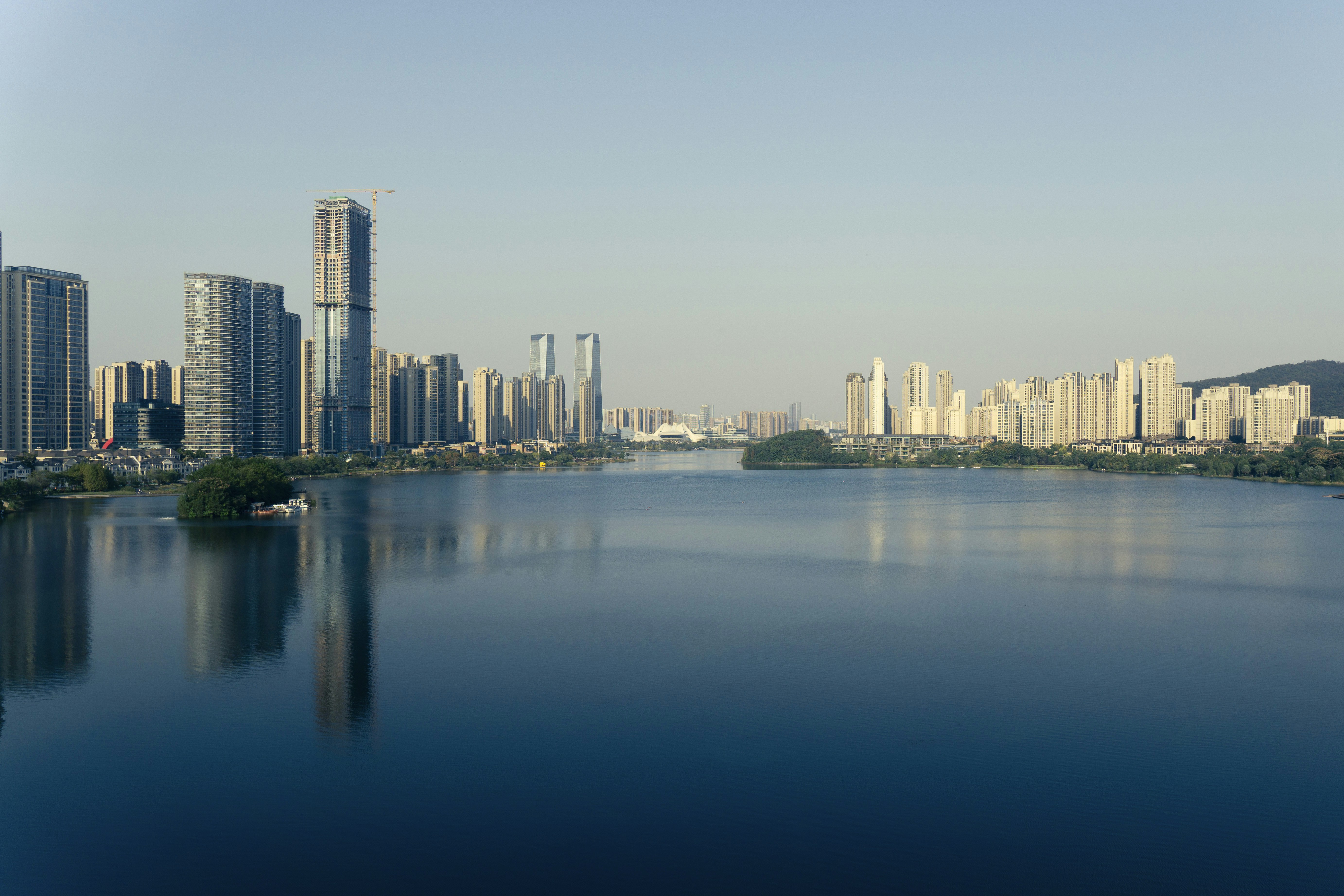 A large body of water surrounded by tall buildings photo – Free Meixi ...