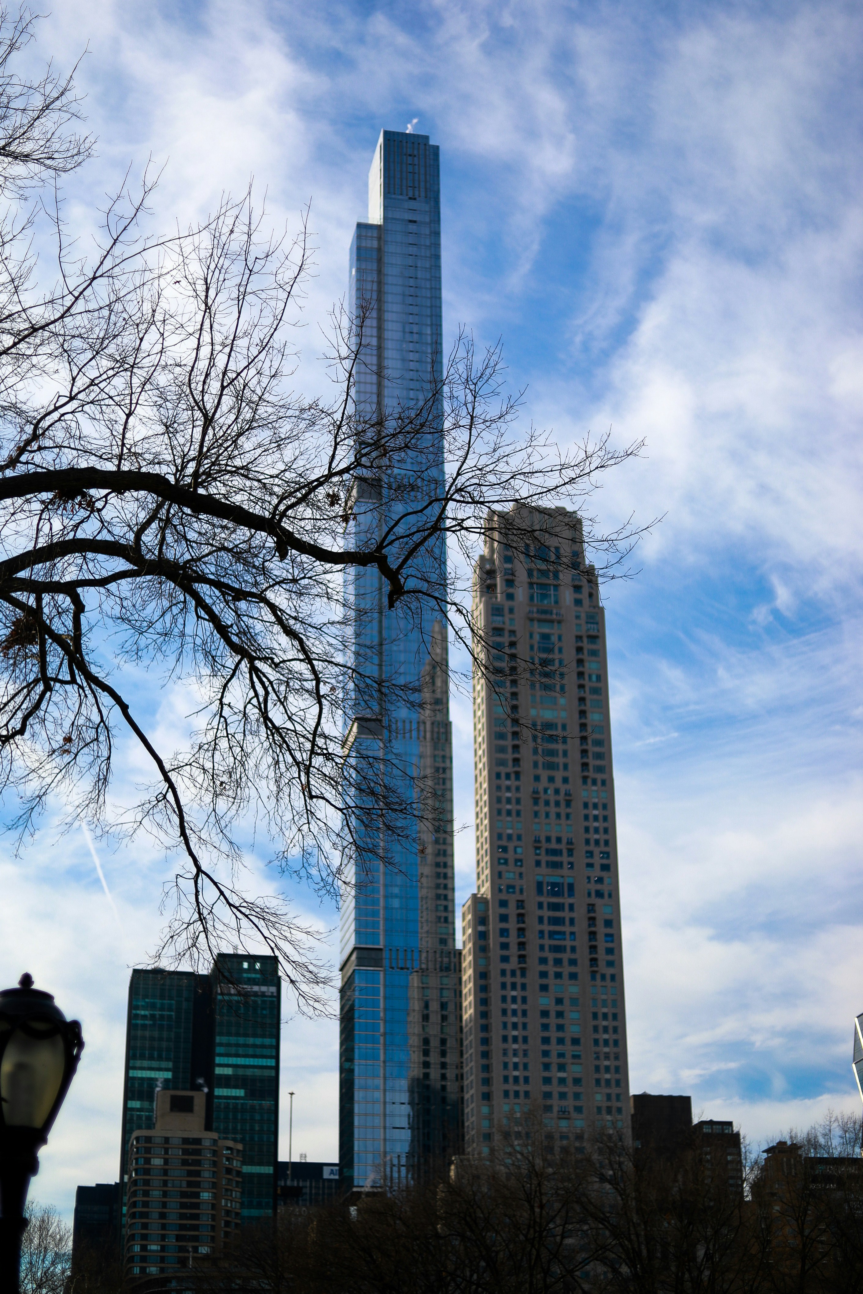 A tall building towering over a city filled with tall buildings photo ...