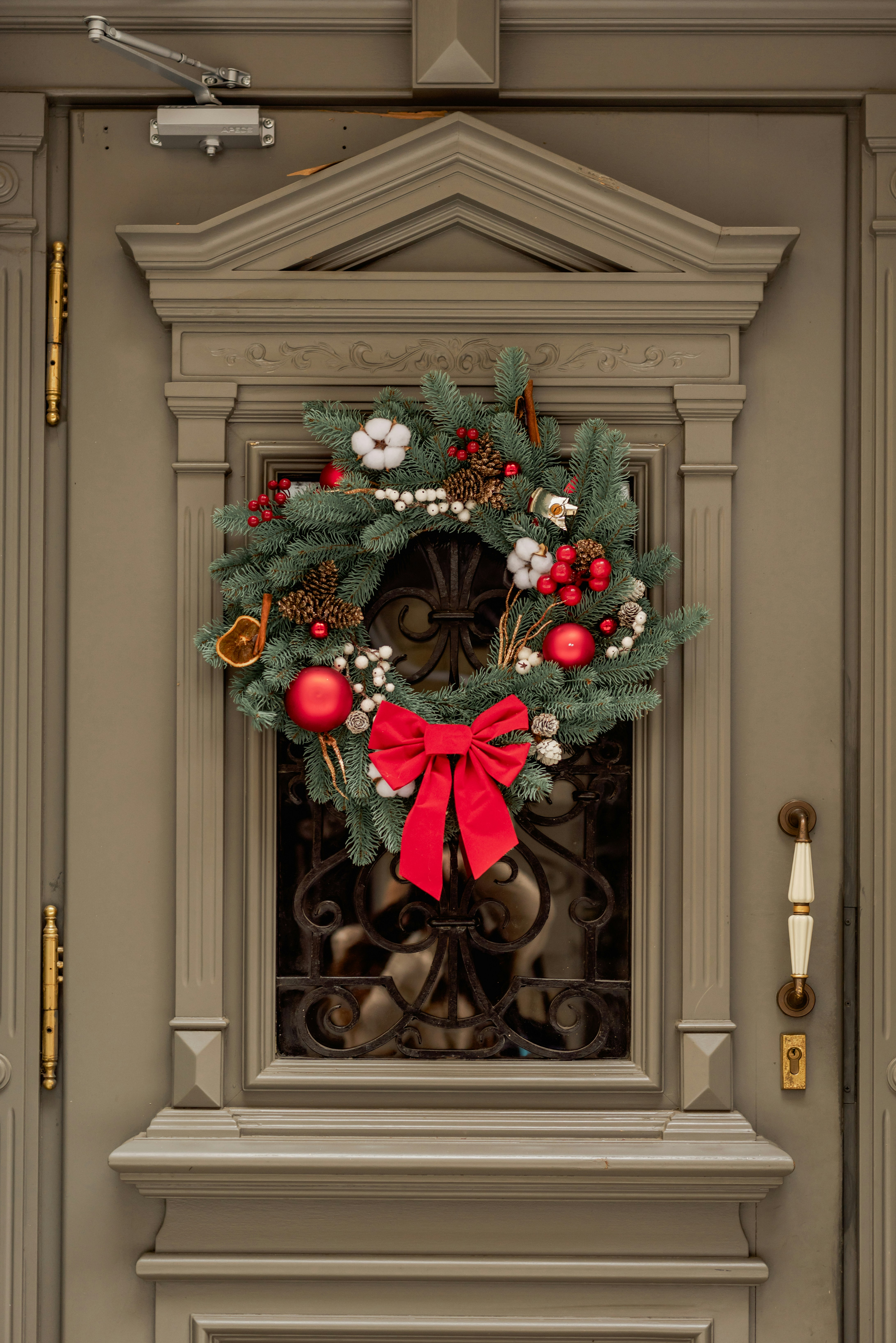 Crimson Bow and Evergreen Wreath Framing a Classic Door
