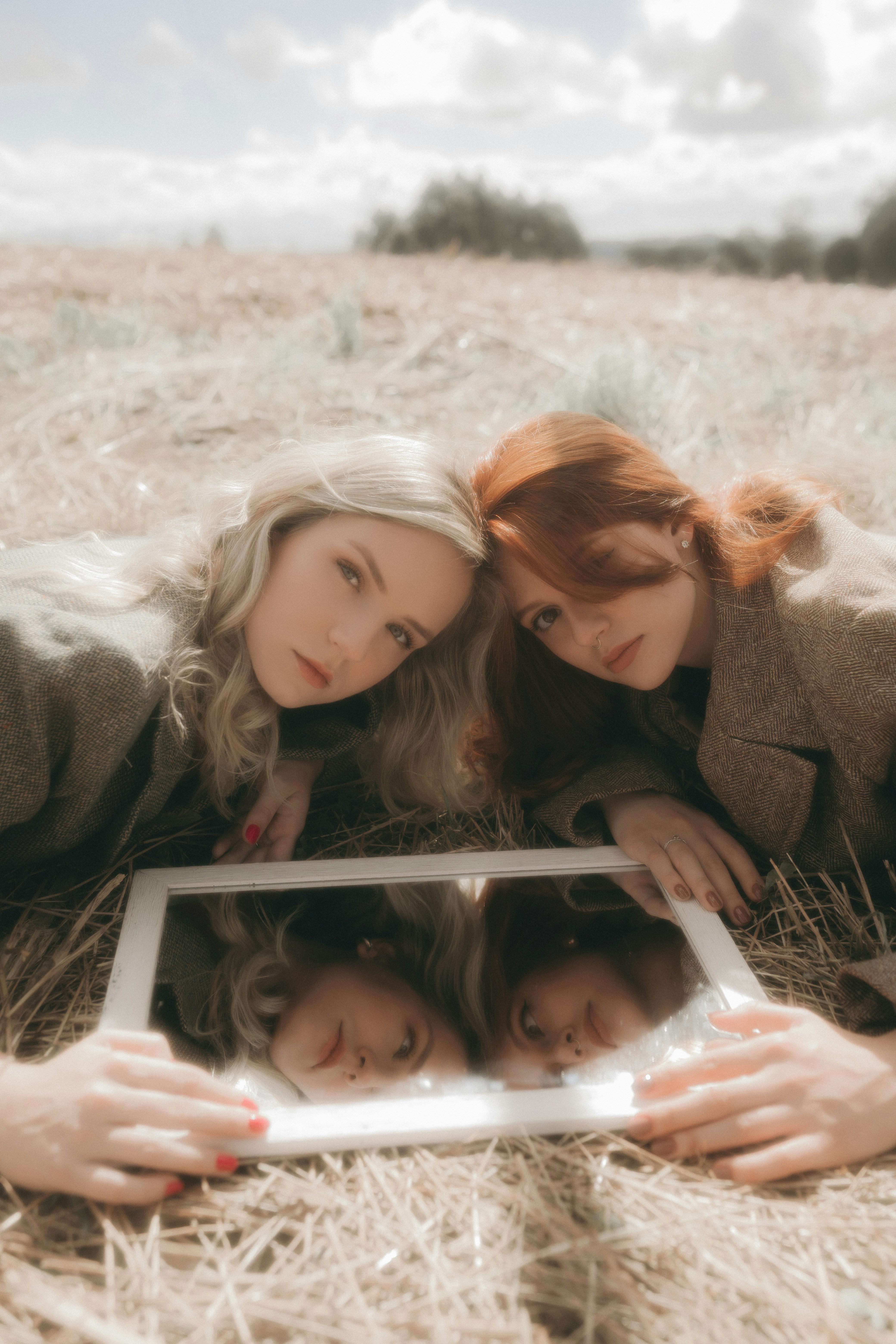 Two women laying on the ground with a tablet photo – Free Portrait ...