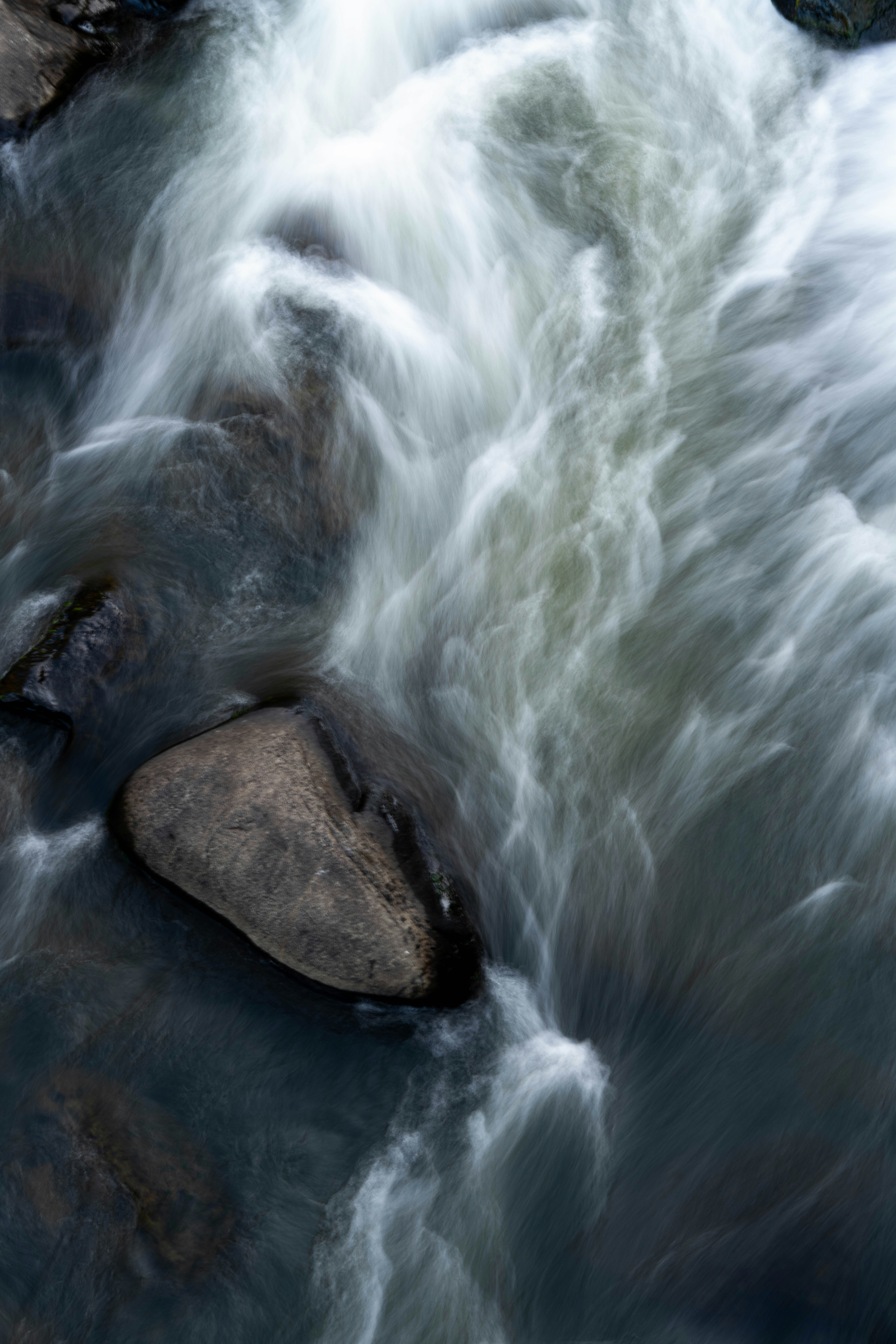 the water is rushing over the rocks in the river