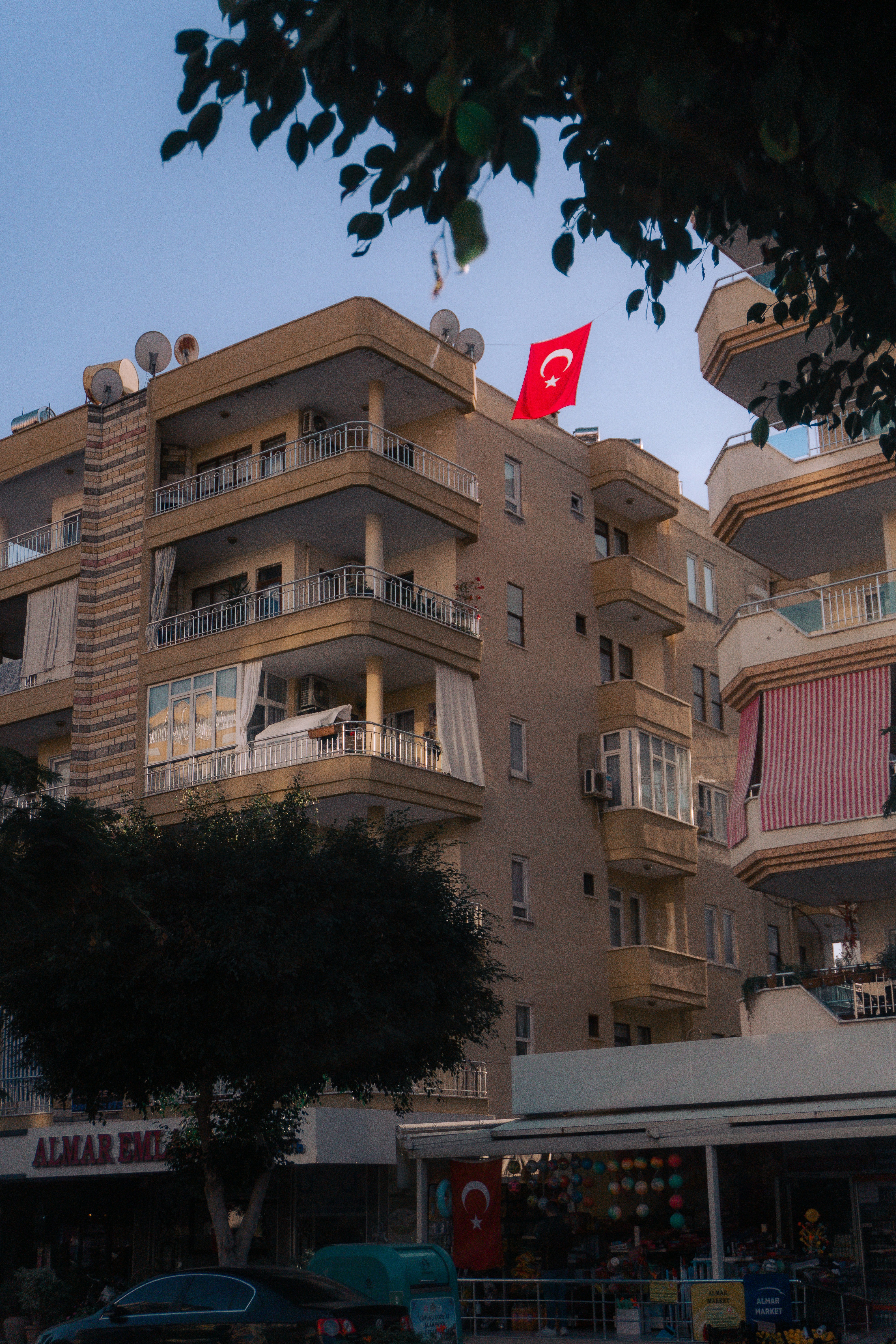Turkish Flag Flutters Above a Balcony Amid Urban Facades