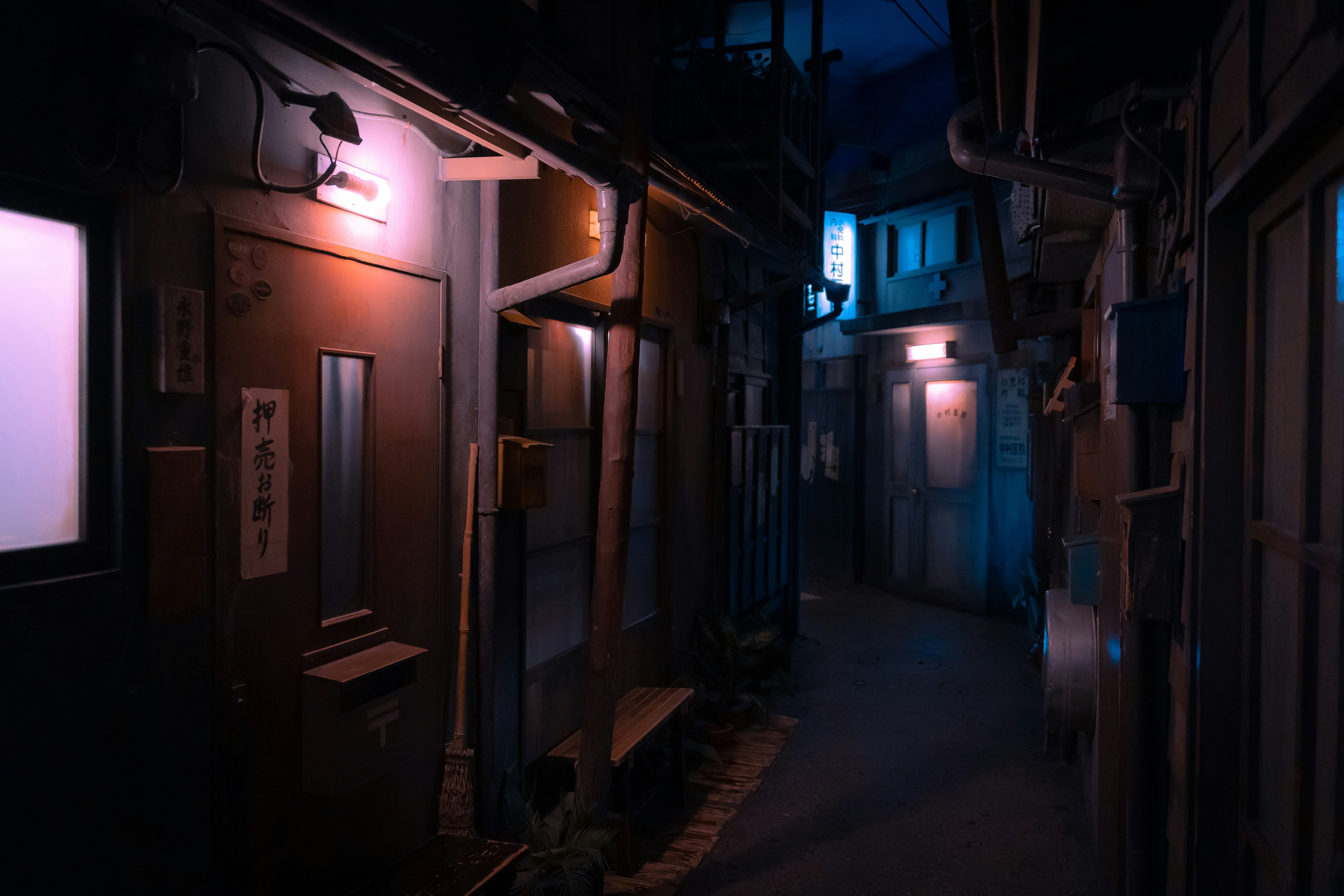 A dimly lit alley with a bench and door photo – Free Yokohama Image on ...