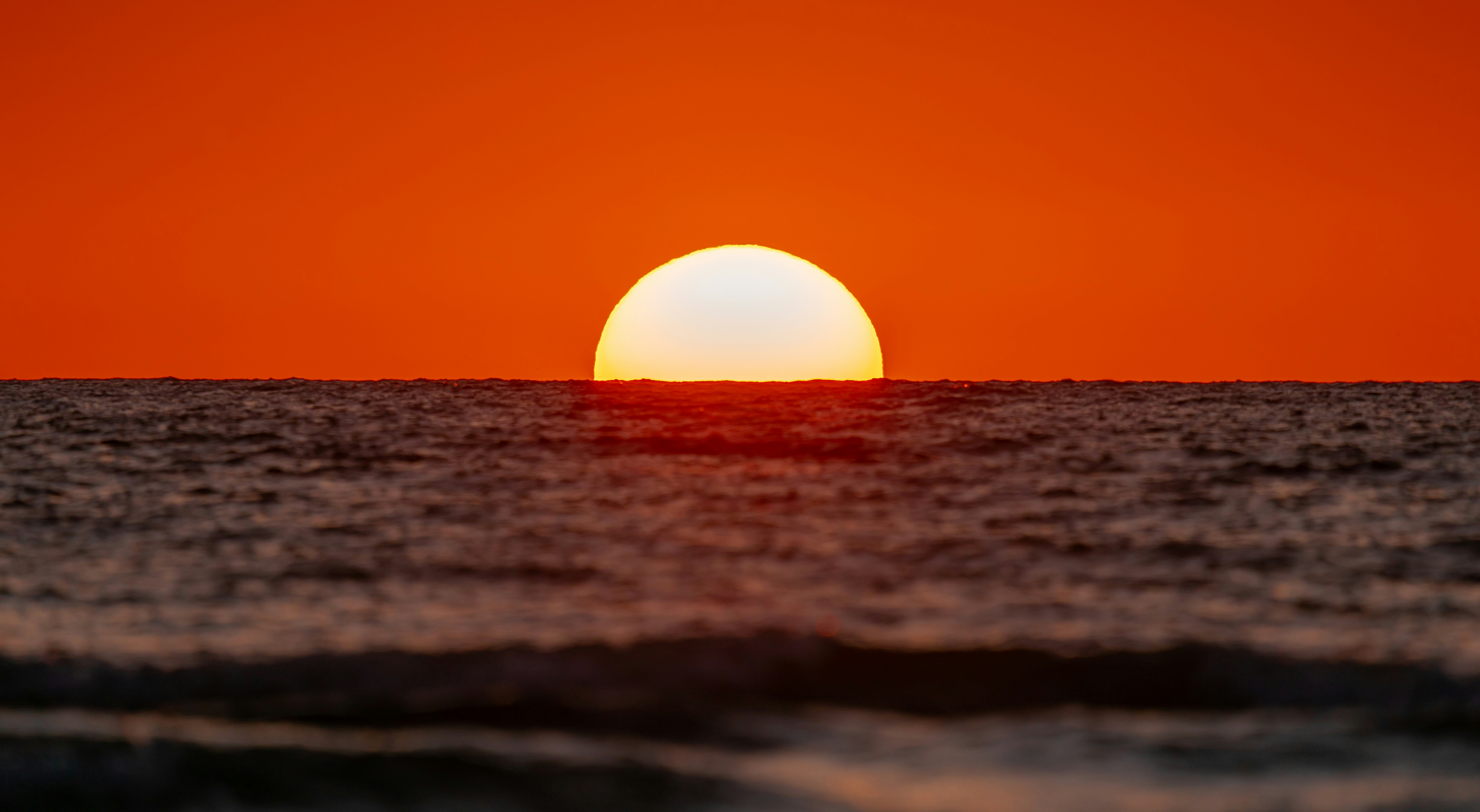 The sun is setting over the ocean on a clear day photo – Free Beach ...