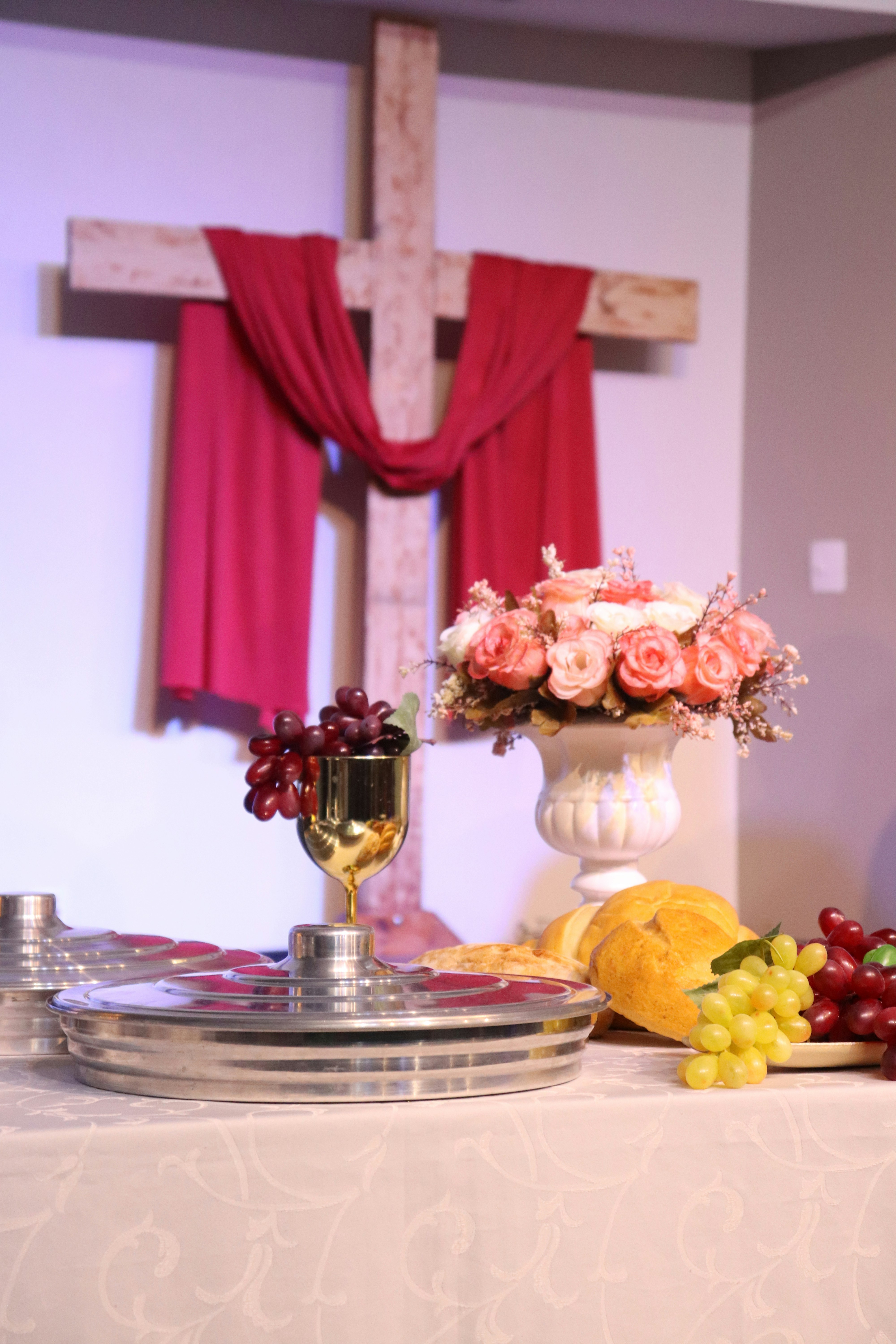 Altar Still Life: Rosy Bouquet Framing the Wooden Cross